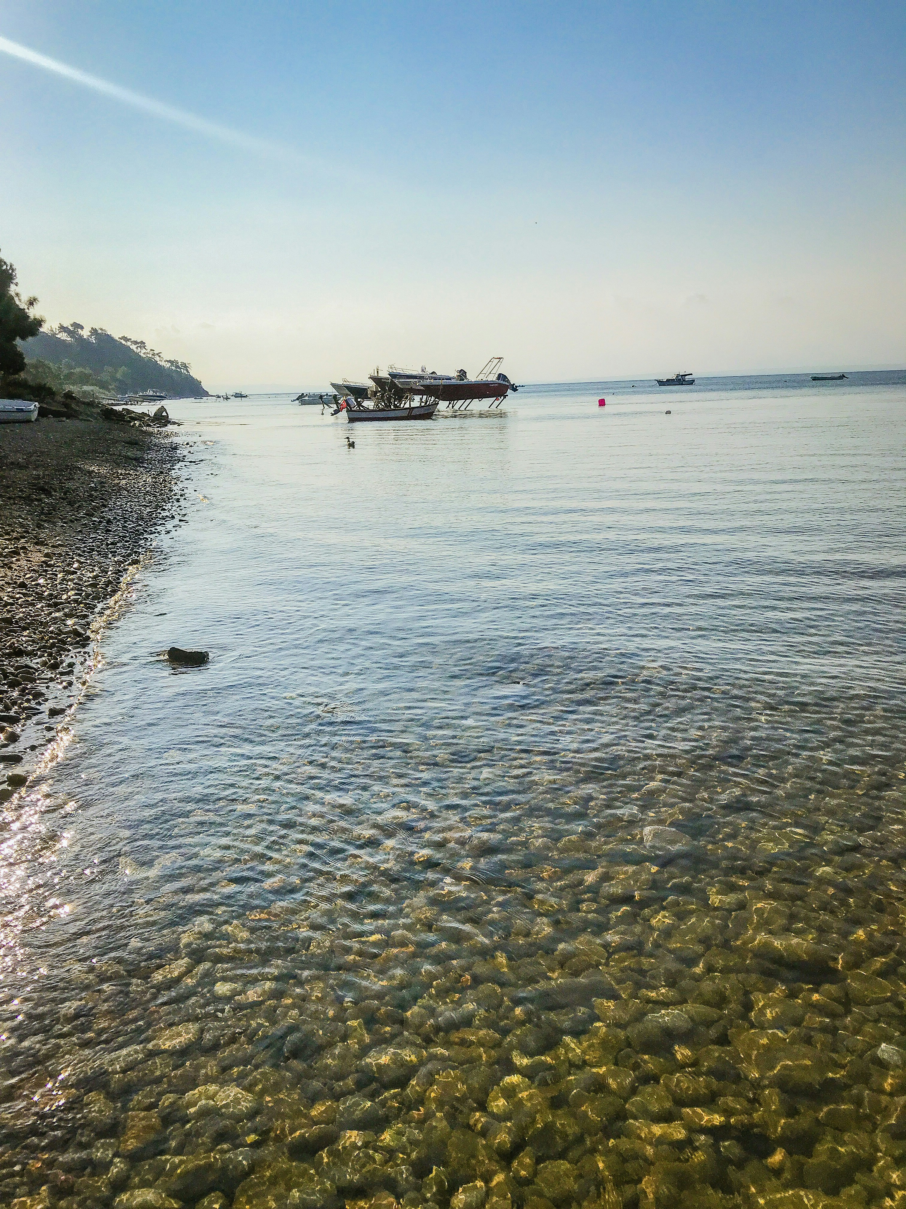 Dawn at the Pebble Harbor: Boats Rest on Glassy Coastal Waters