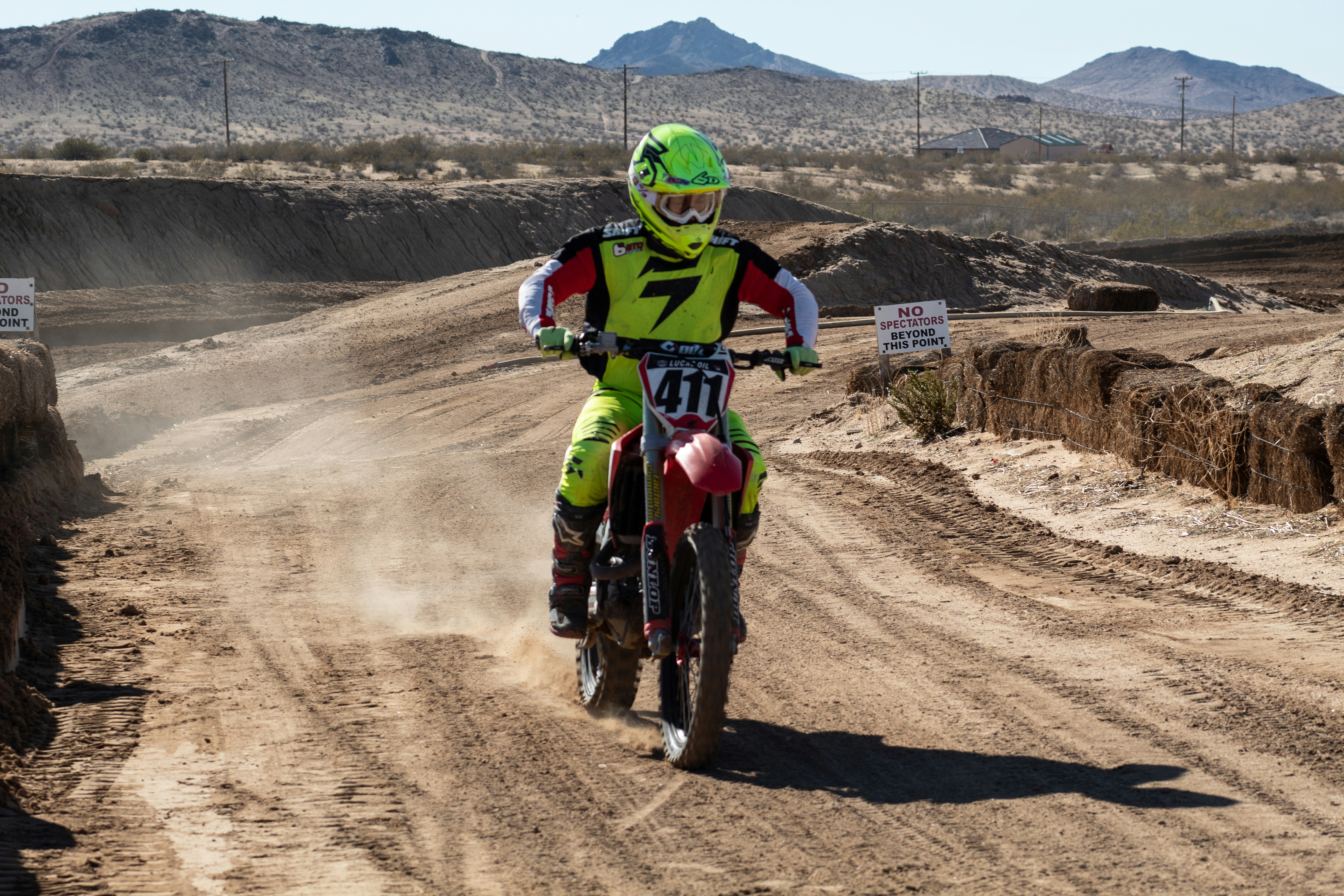 Motocross in the desert | man in green and black motocross suit riding motocross dirt bike