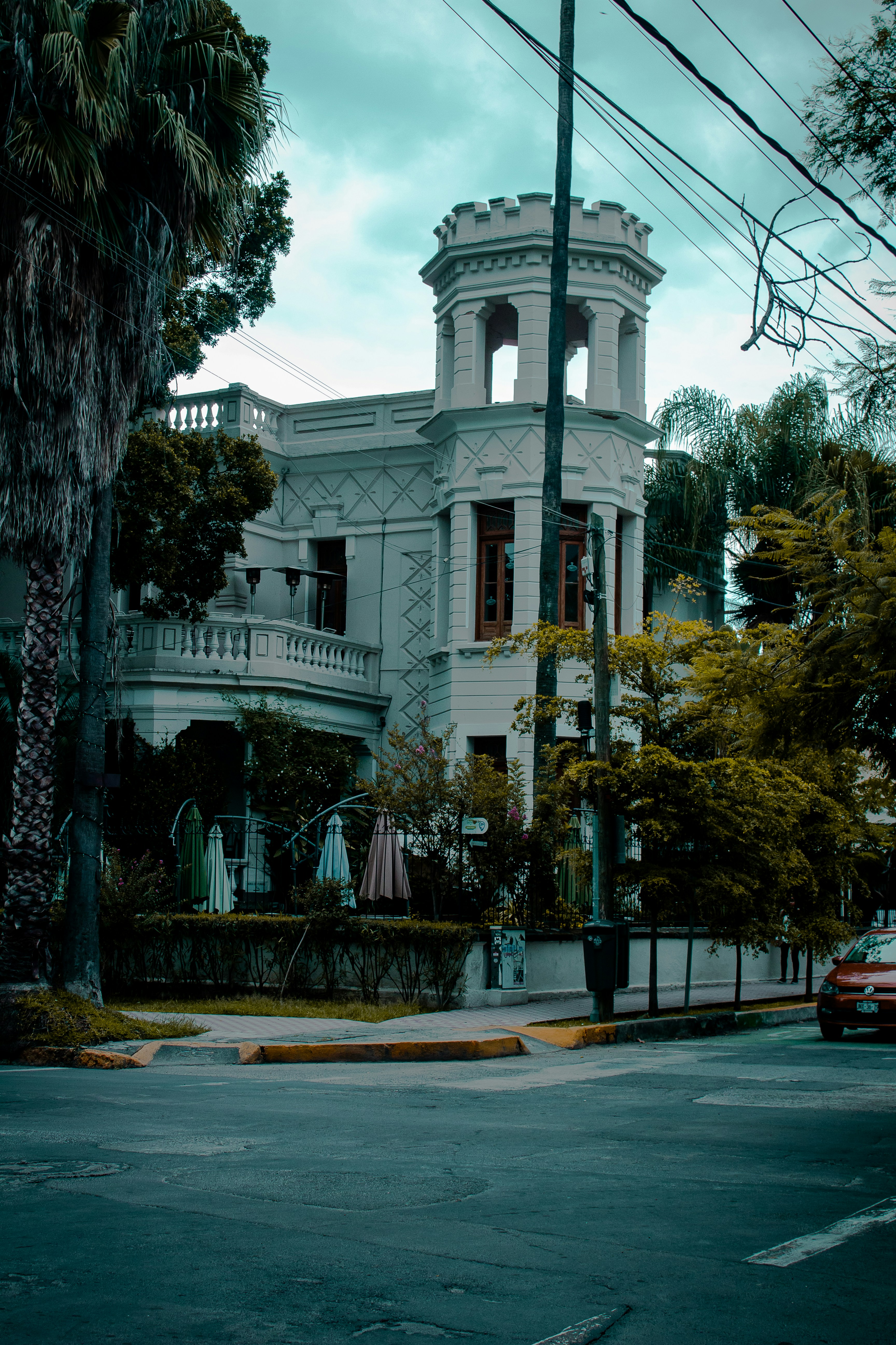 Turreted White Villa Punctuates a Quiet Urban Street