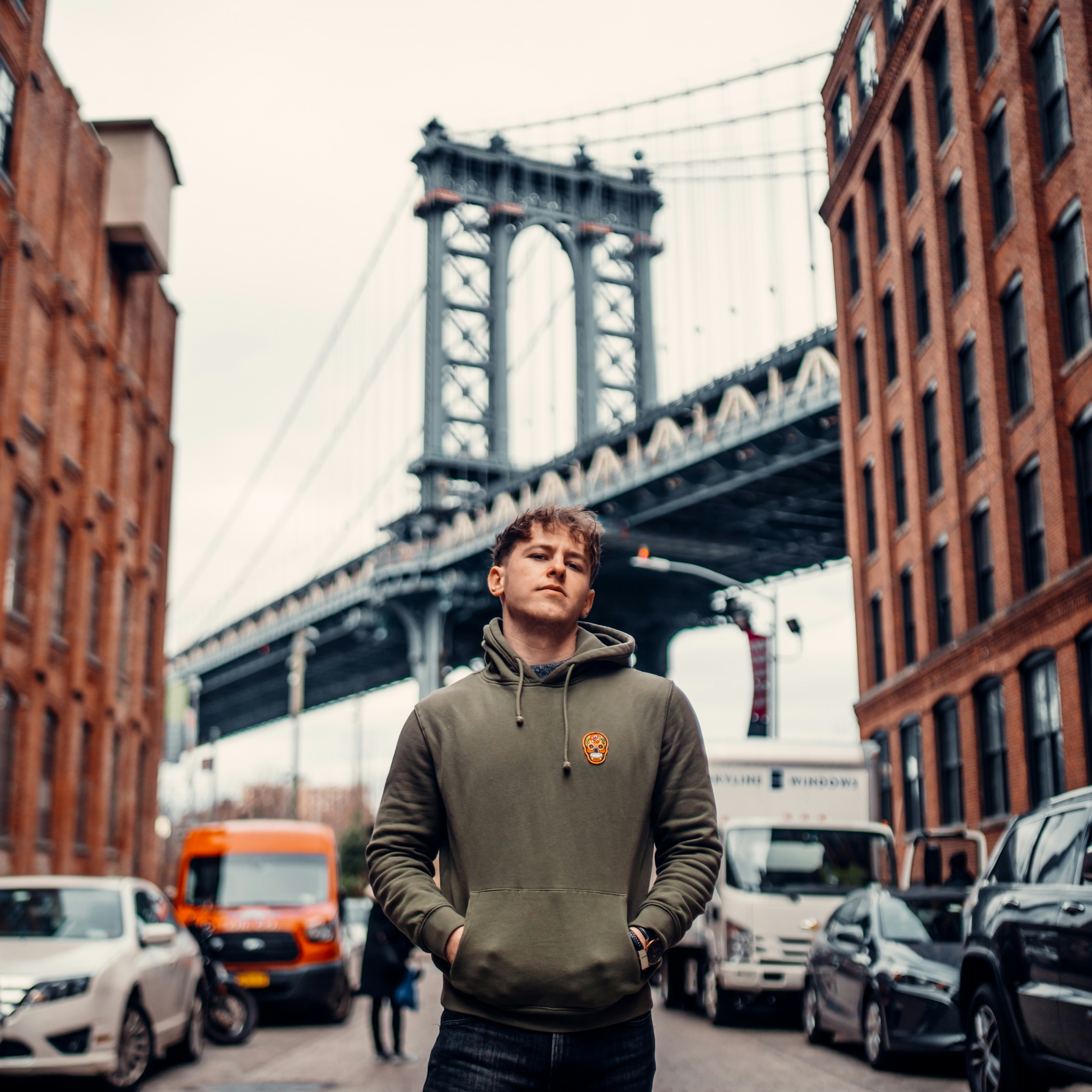 Under the Span: Hoodie Portrait Beneath a Timeworn Bridge