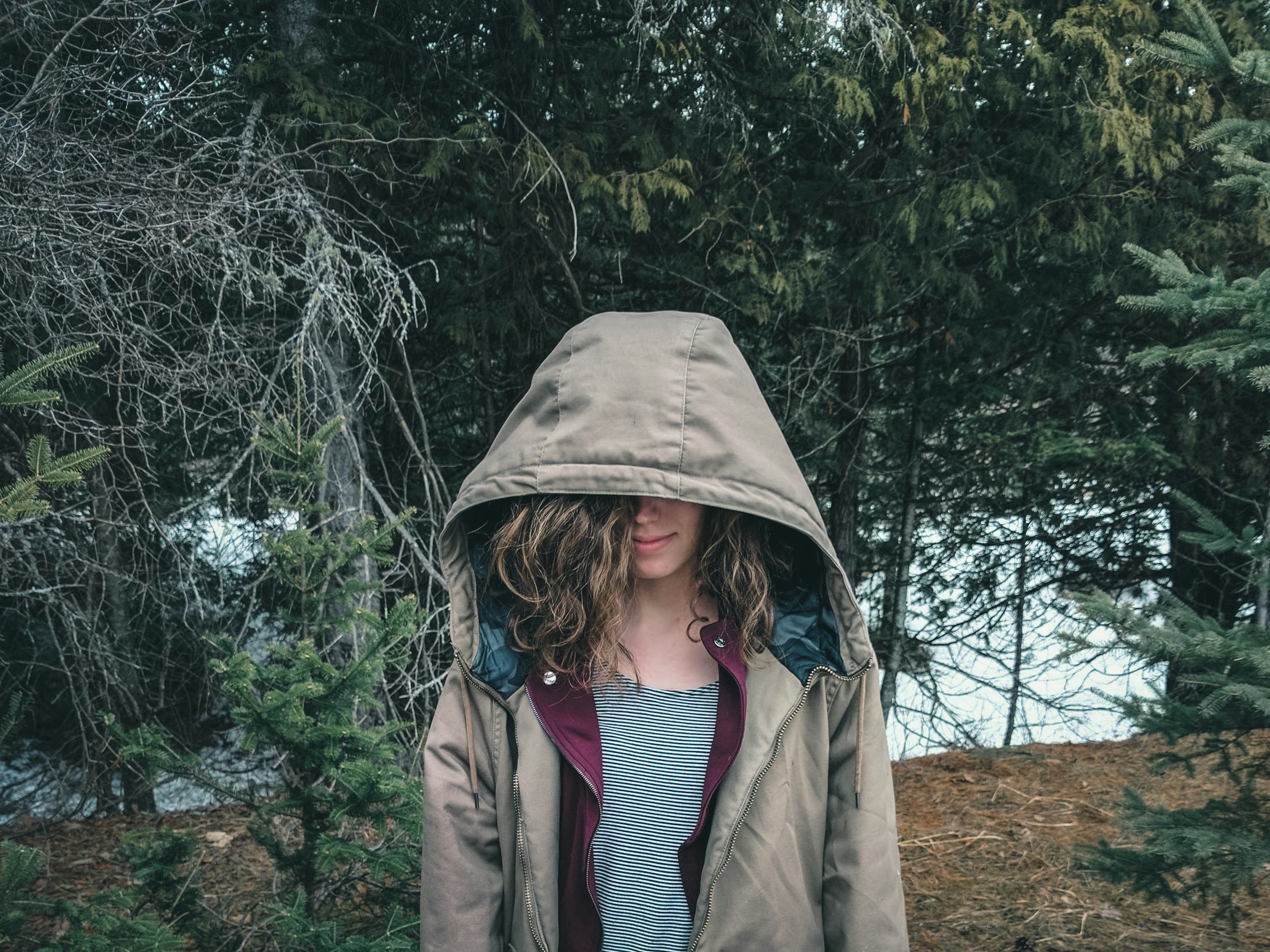 She stole my jacket | woman in brown coat standing near green trees during daytime