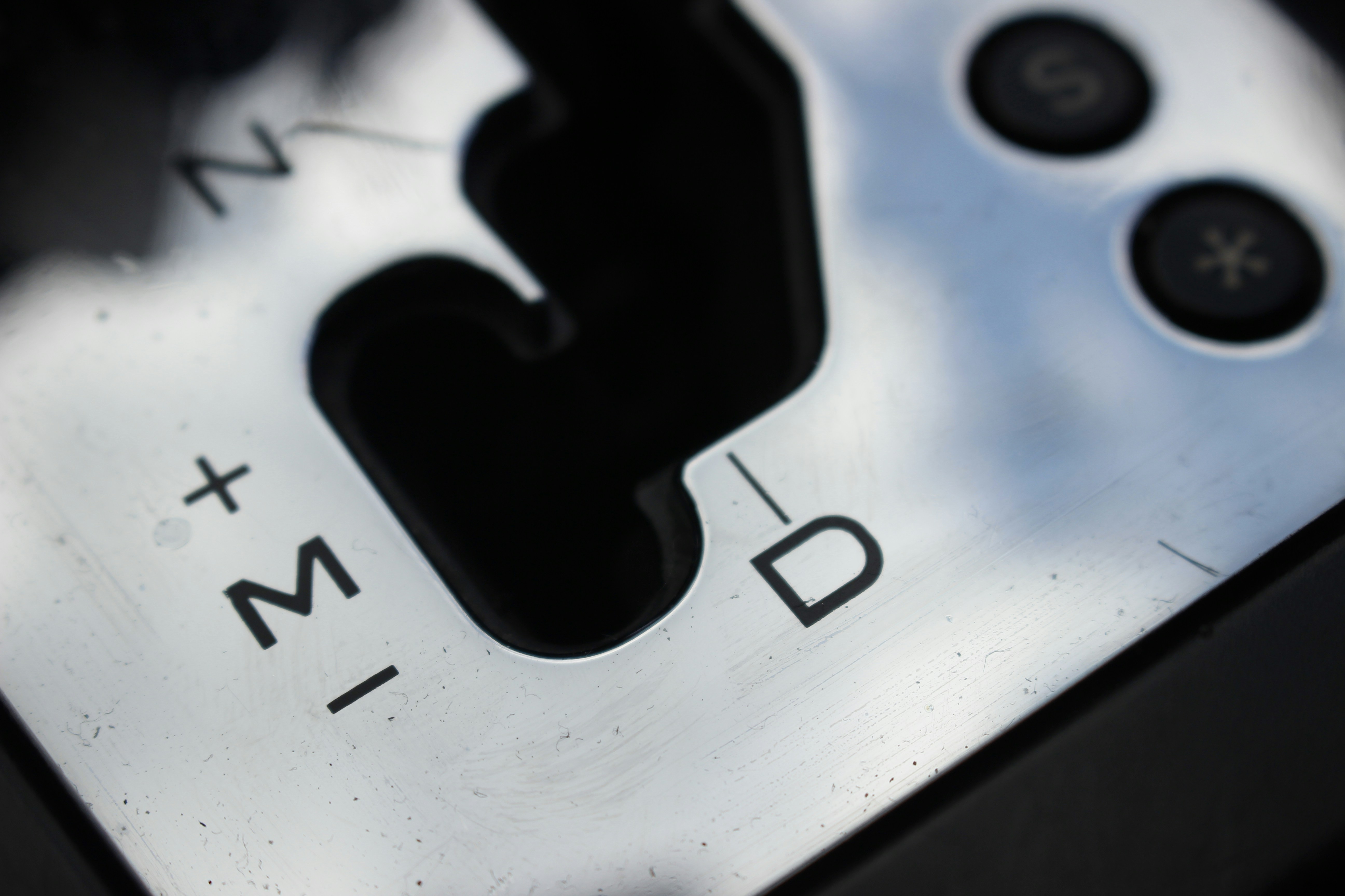 Chrome Gate: Macro Focus on a Car's Manual-Mode Shift Gate