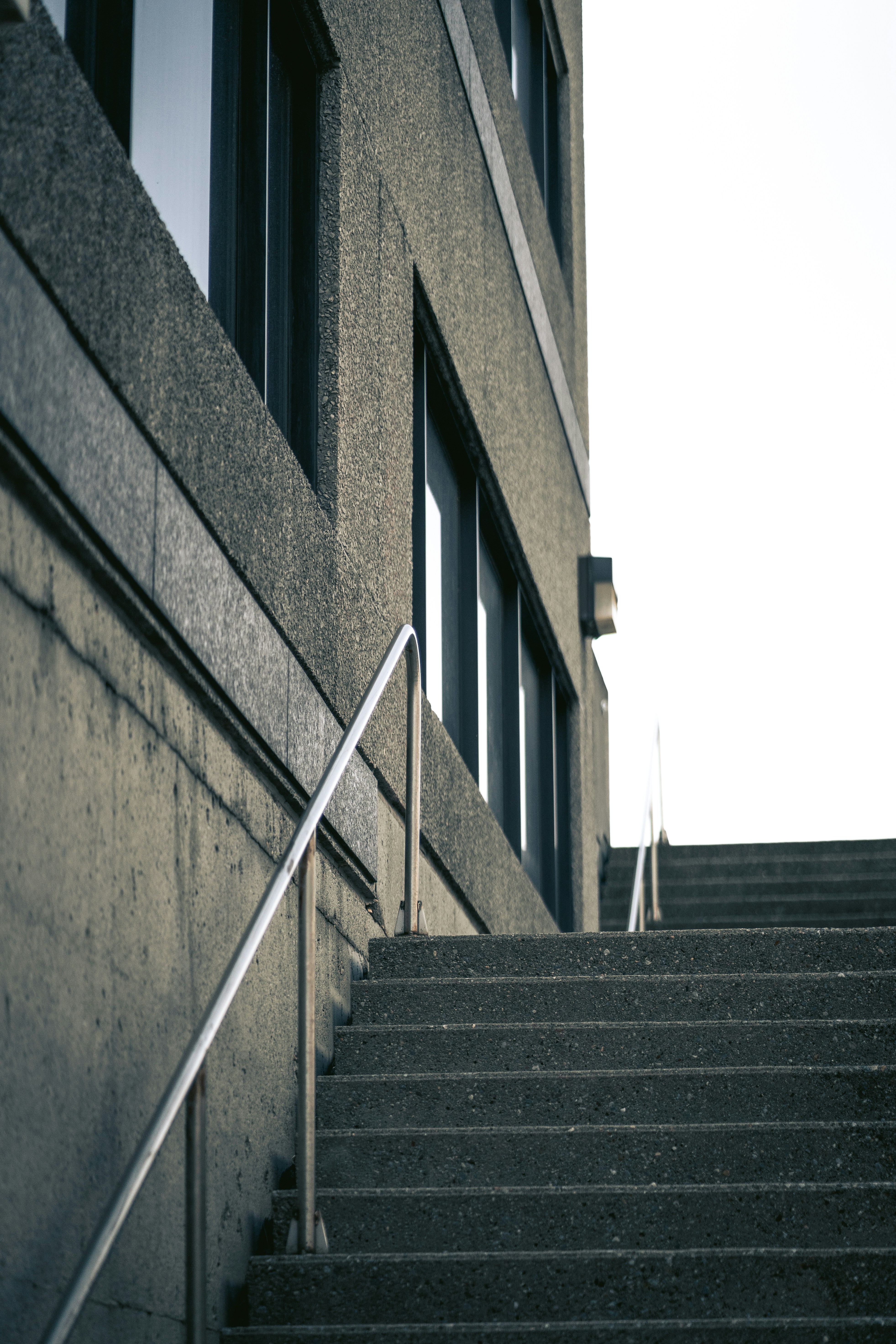 Black staircase in front of brown concrete building photo – Free Grey ...
