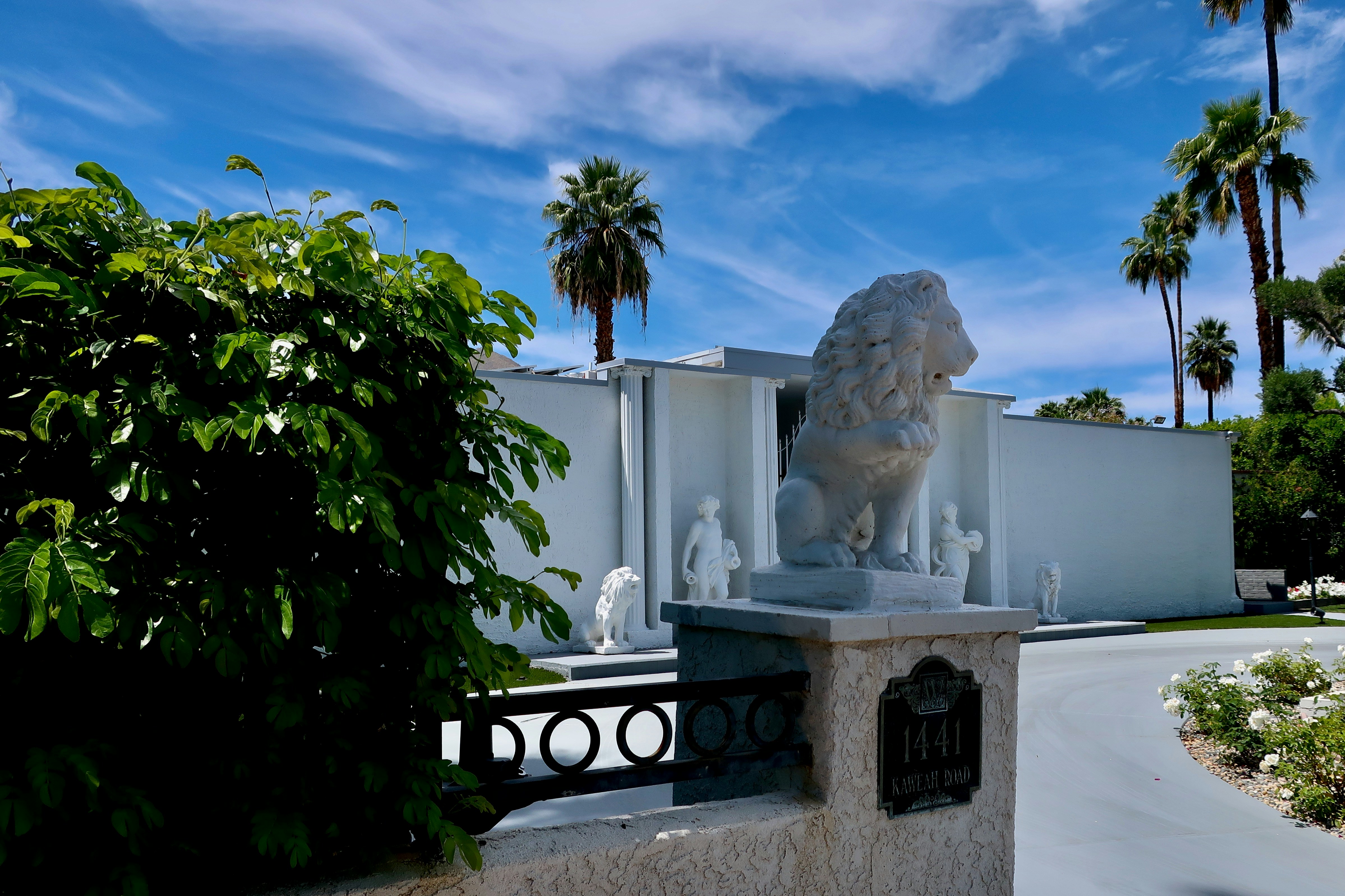 Sunlit Marble Lions at the Gate of a Minimalist White Courtyard