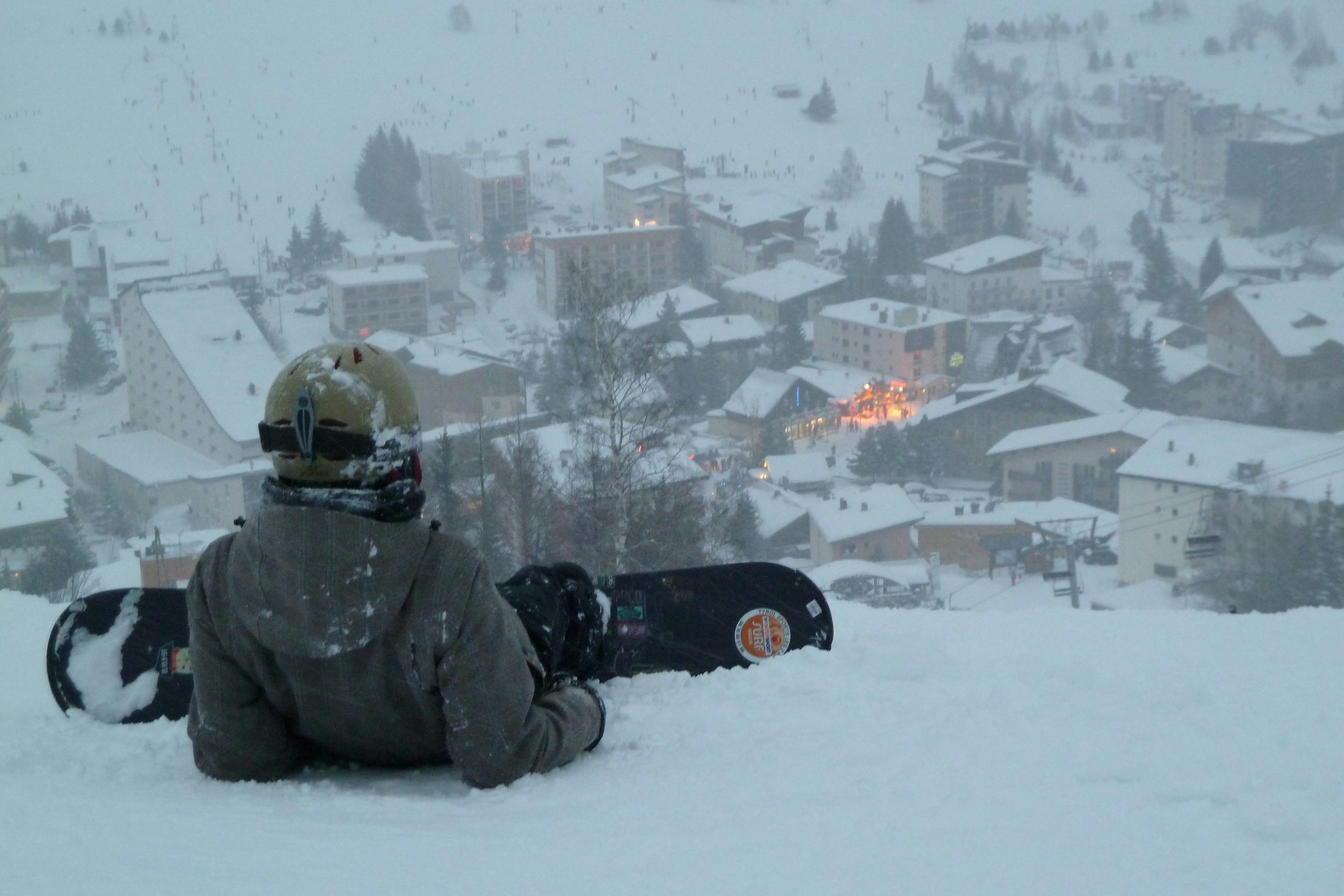 Snowbound Recline: Snowboarder at the City Edge