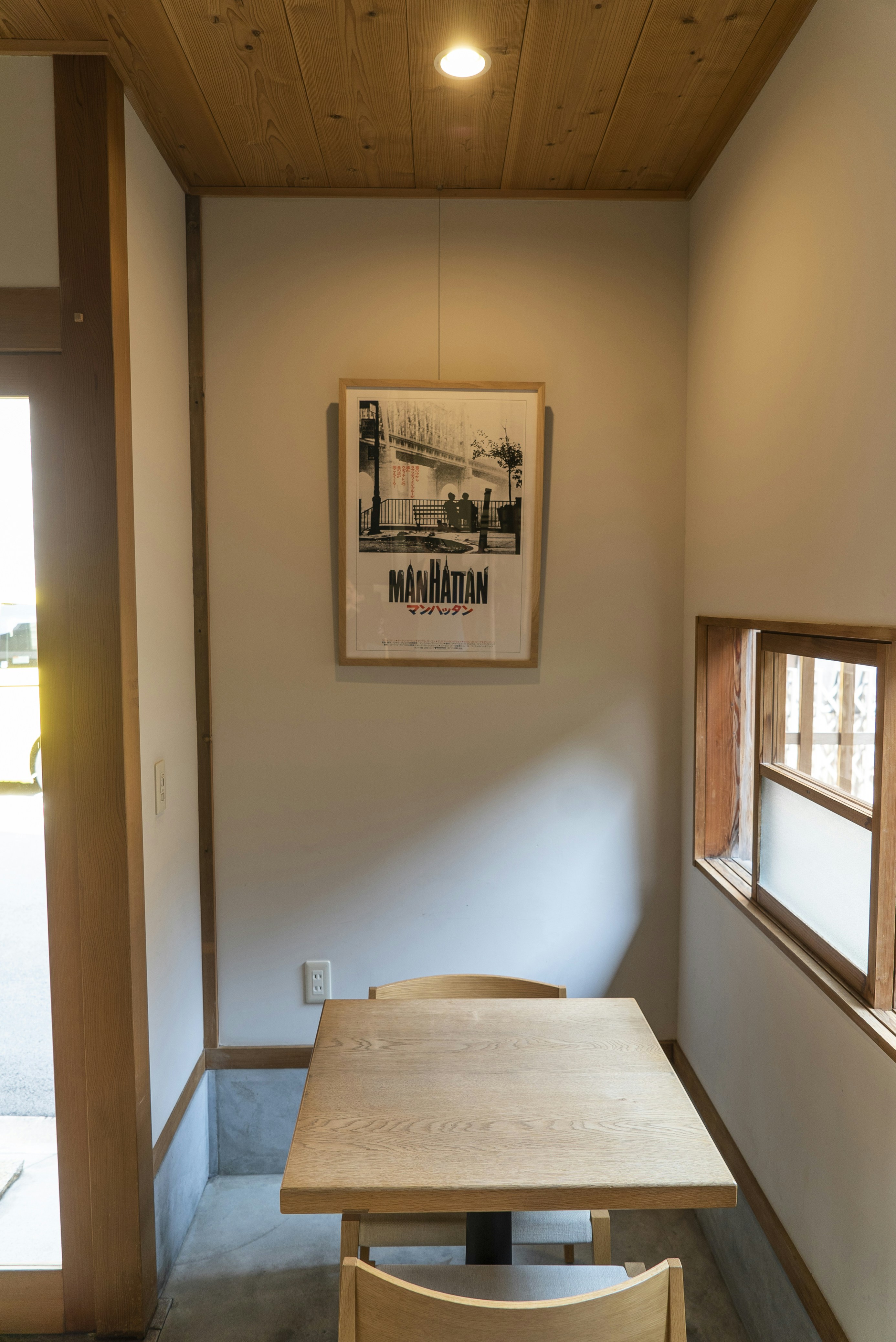 brown wooden table near white wall