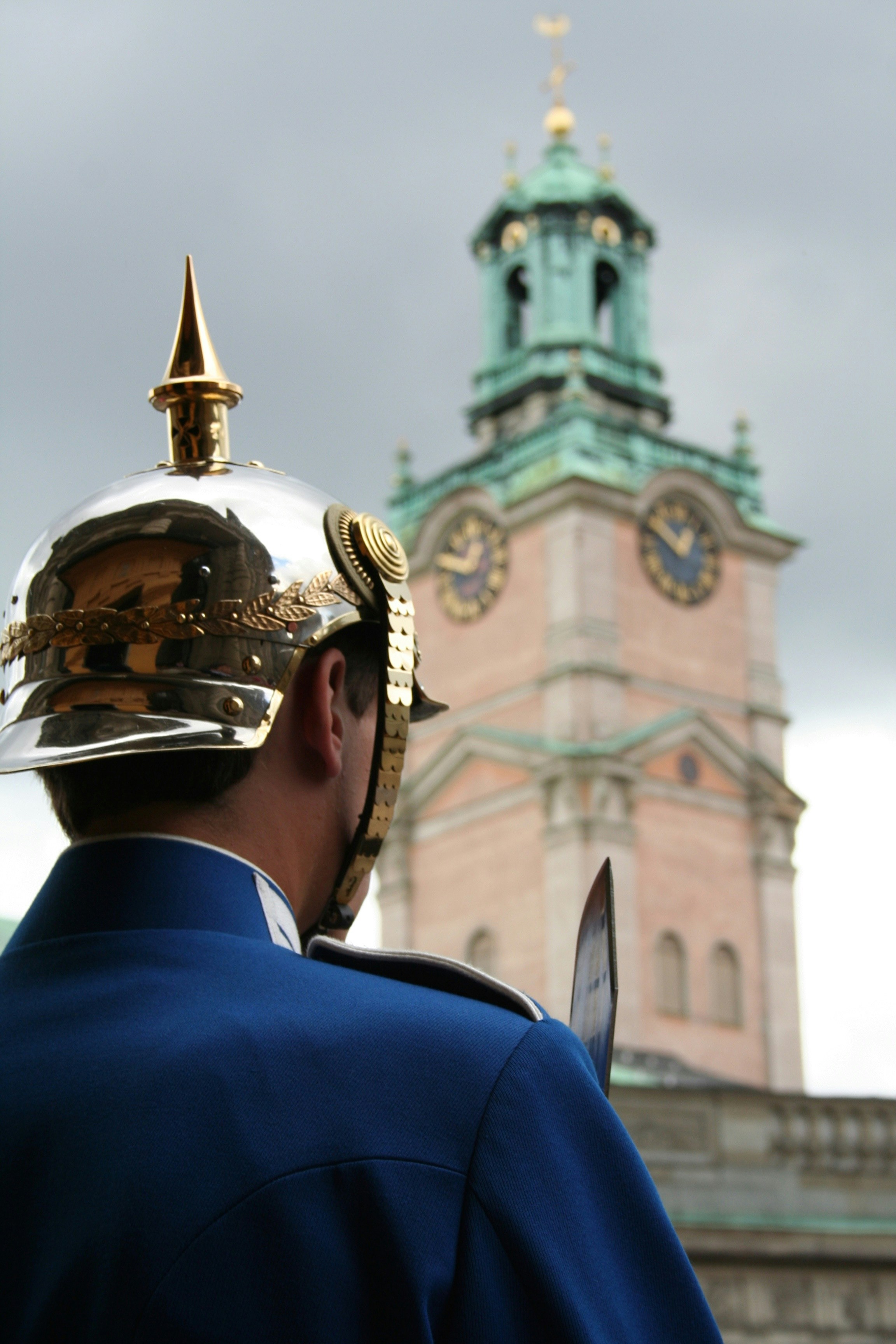 man in blue shirt wearing gold helmet