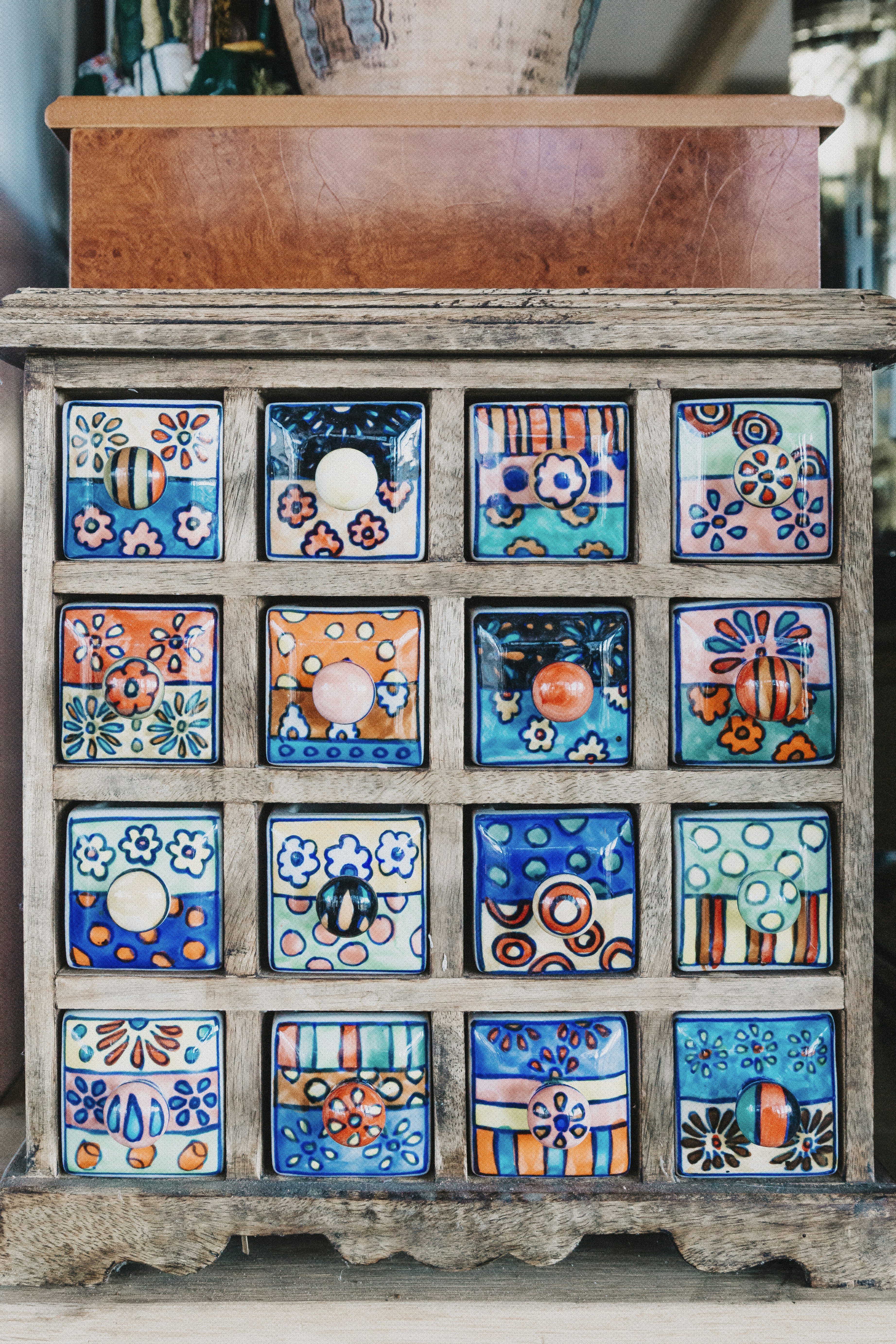 Colorful Ceramic Drawer Rows: Hand-Painted Squares on Weathered Chest