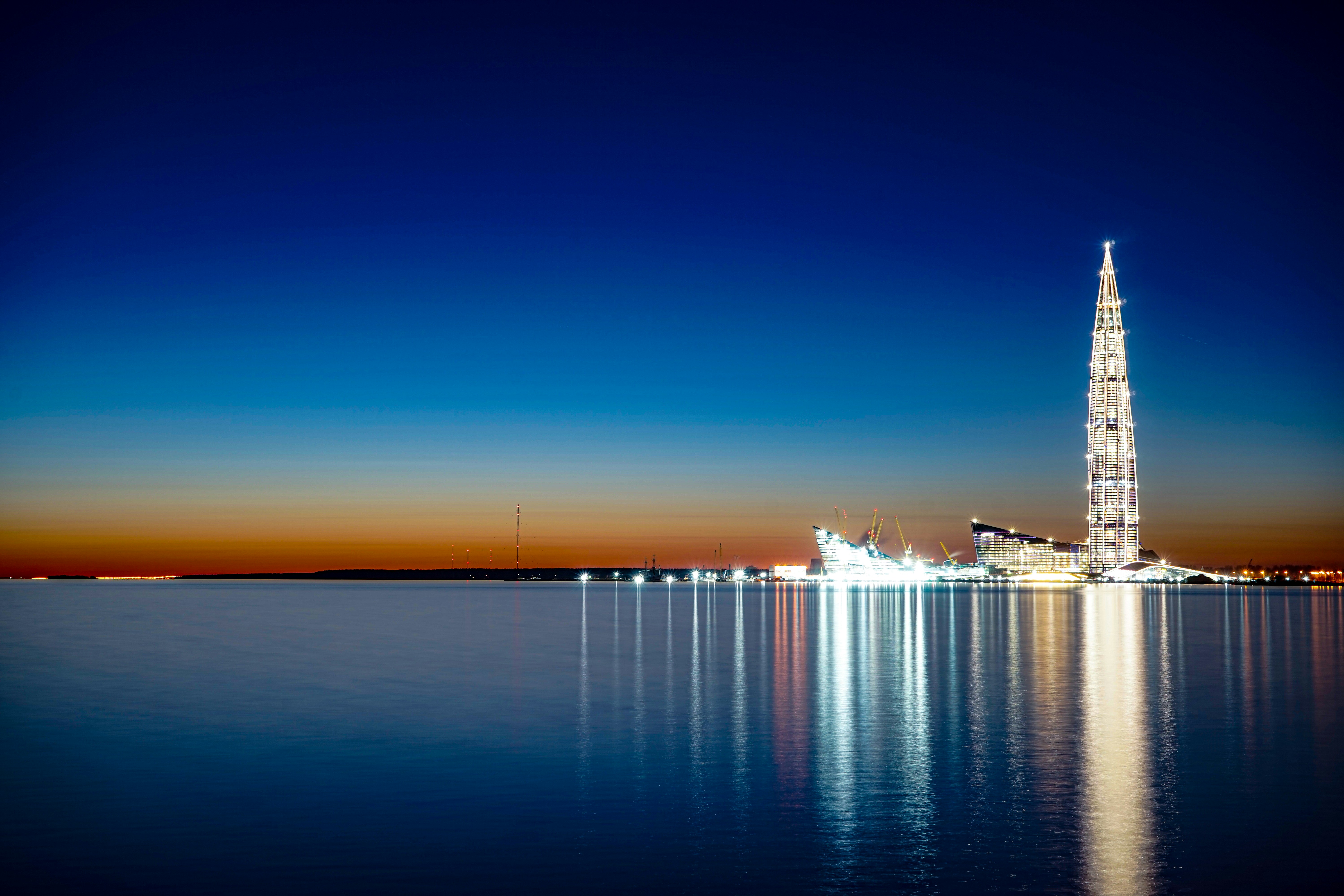 White and black building near body of water during night time photo ...
