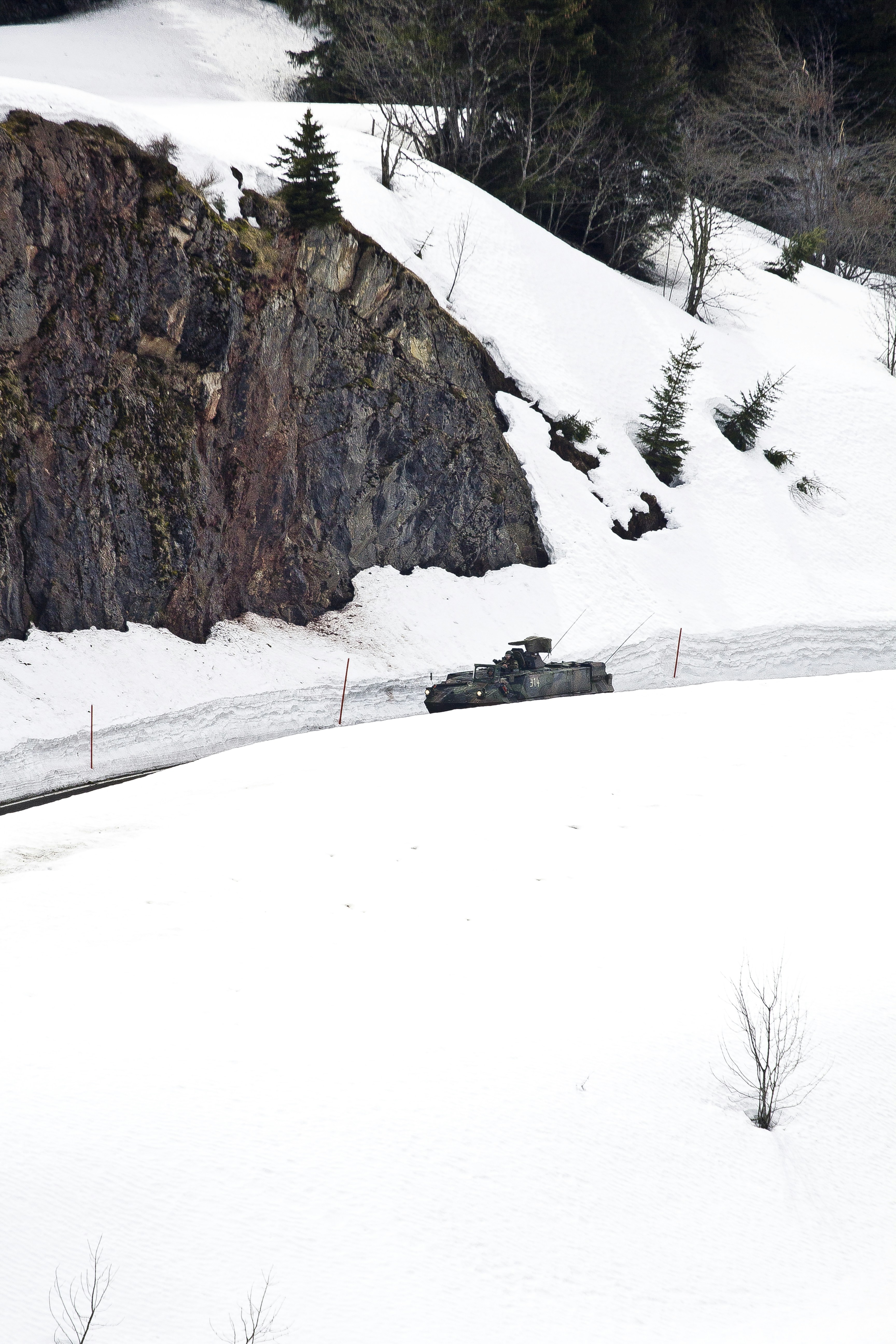 Snowbound Convoy: Tank Trundling Along a Icy Cliff