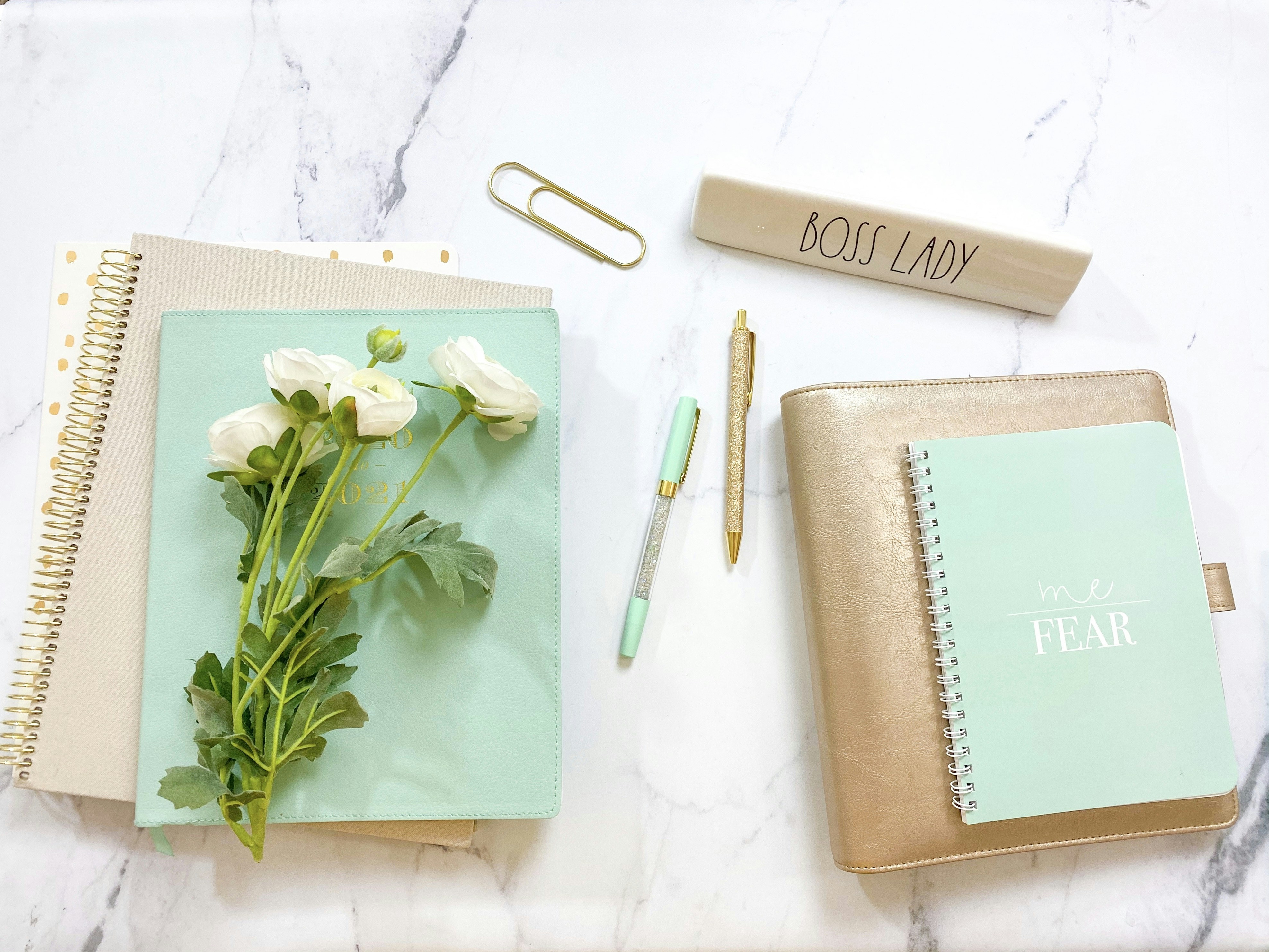 A desk with a notebook, pen, and flowers on it photo – Free Text Image ...