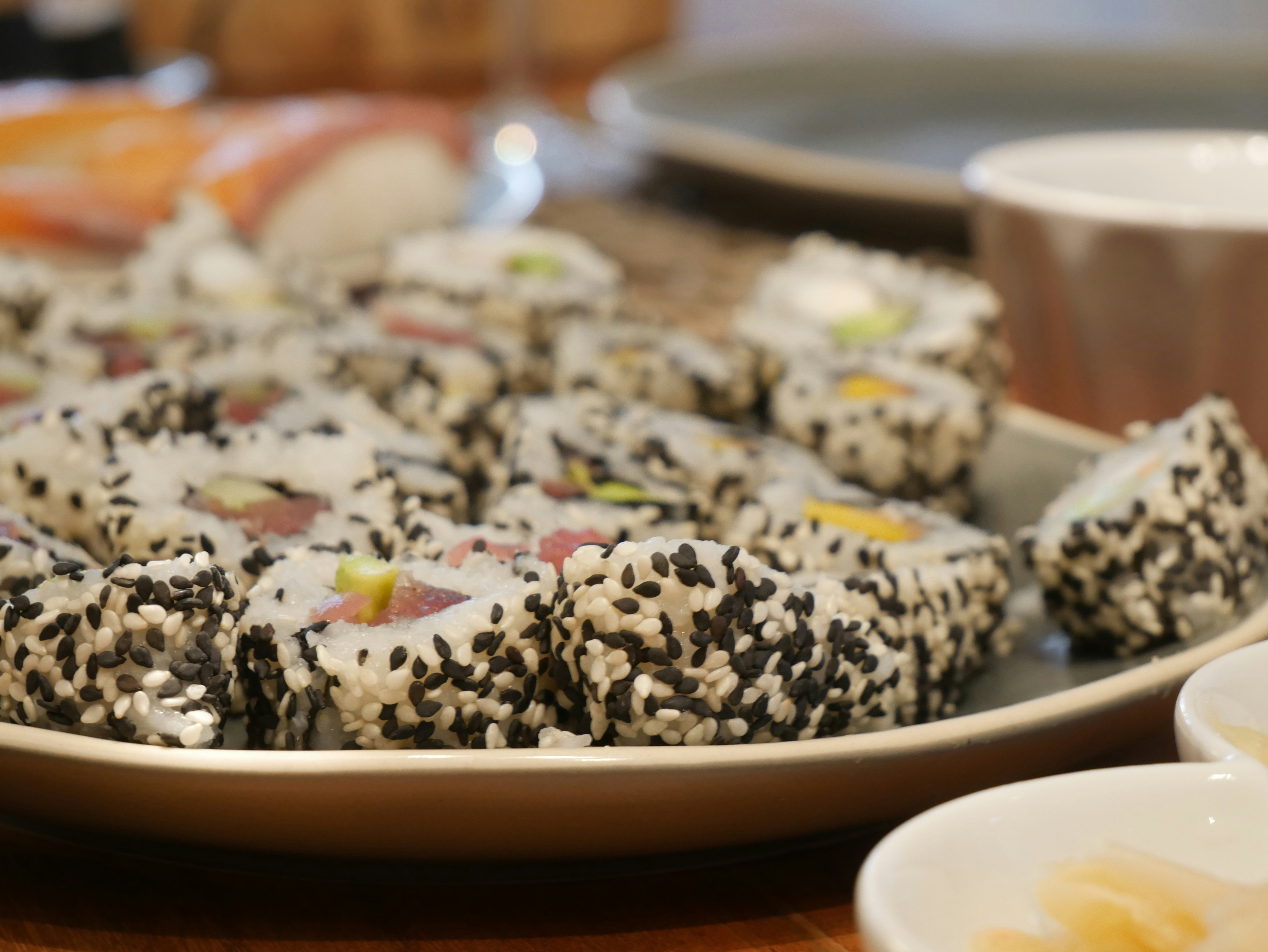 Sesame-Sealed Sushi Rolls on a Shared Platter
