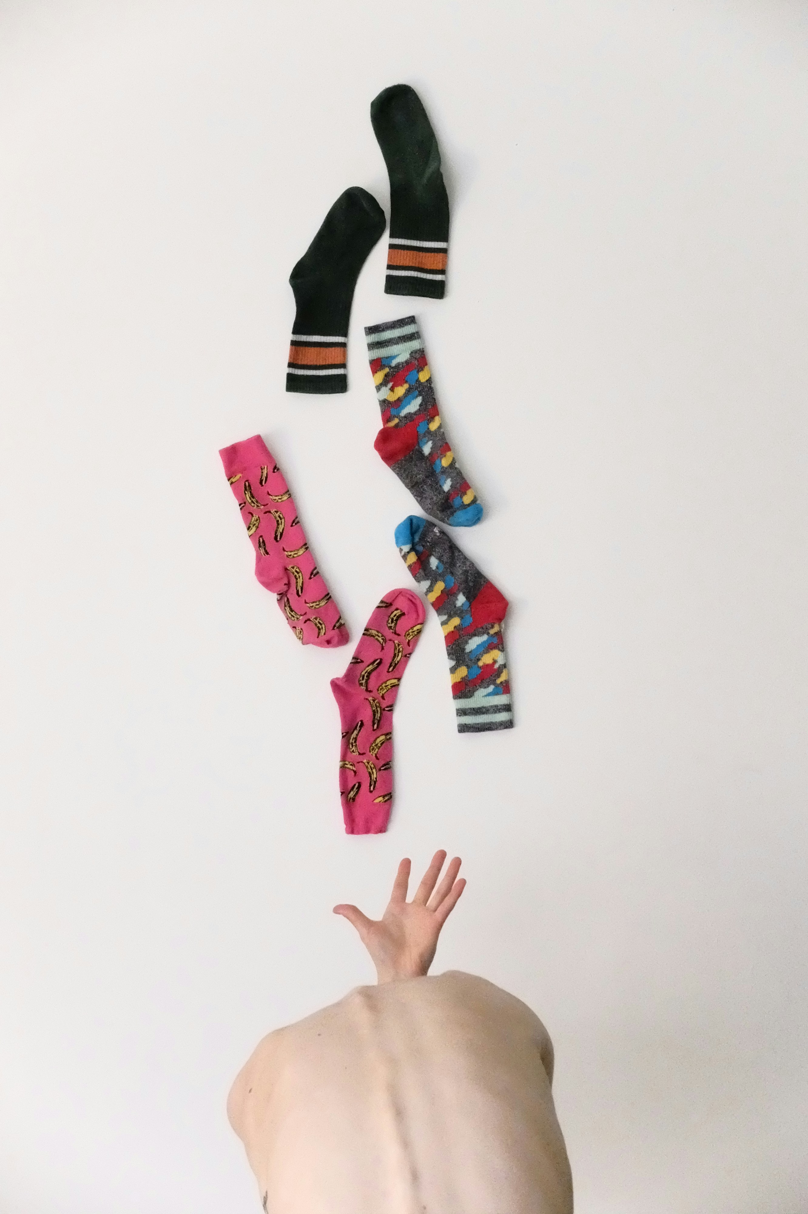 Socks in Freefall: A Last-Minute Toss toward the Hand