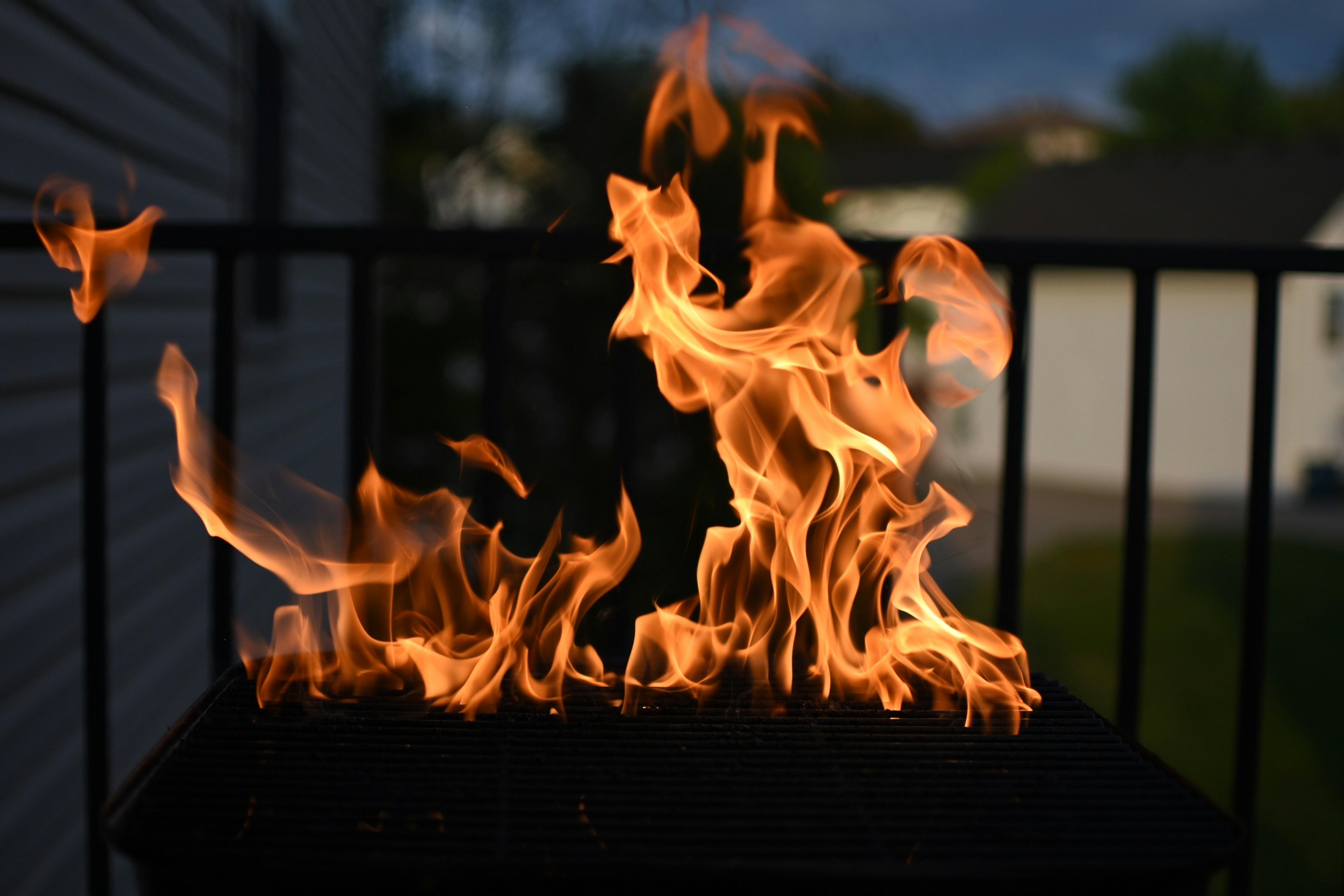 Fire in front of black metal fence during daytime photo – Free United ...