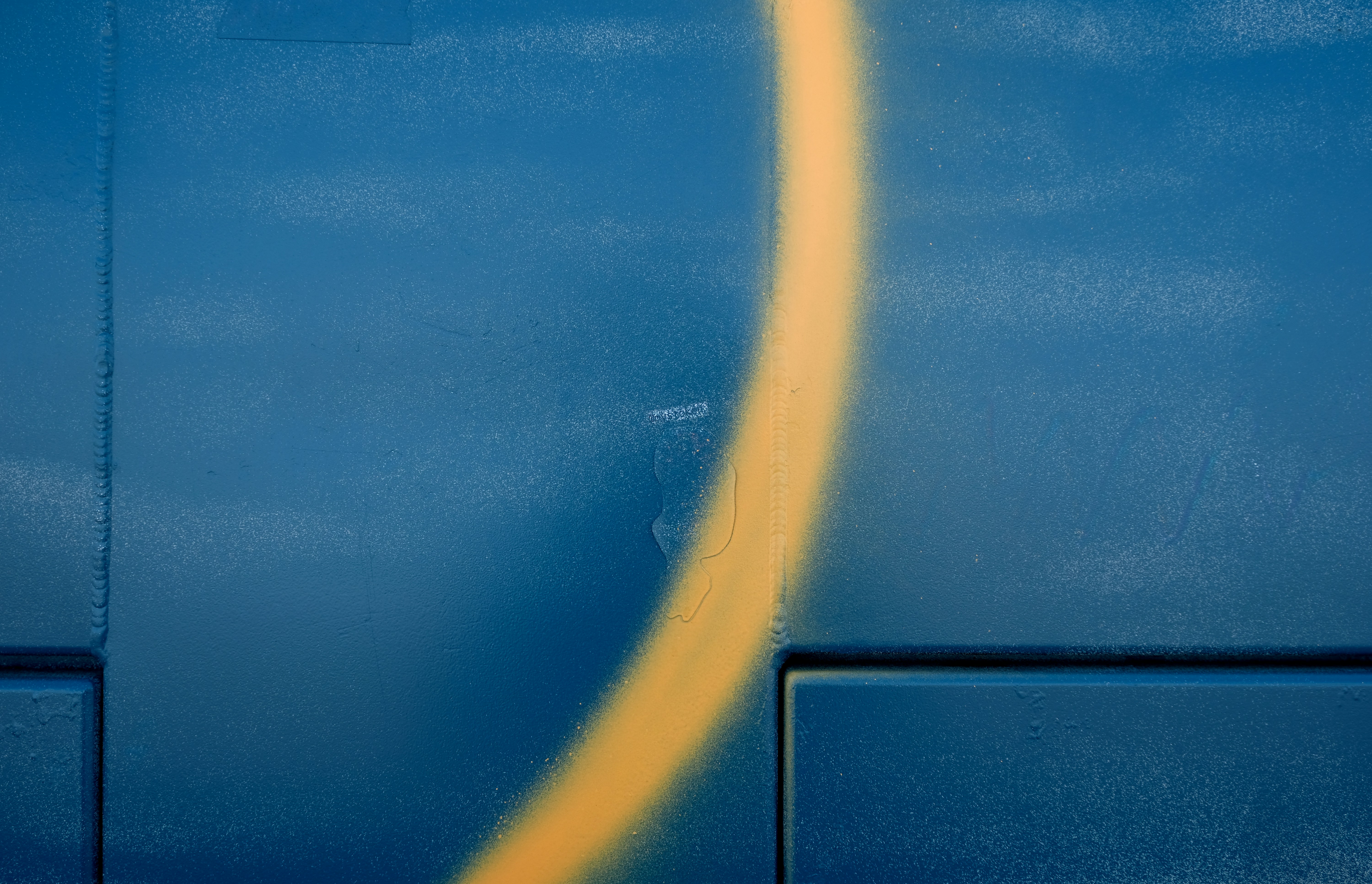 Yellow Arc over a Blue Geometric Surface