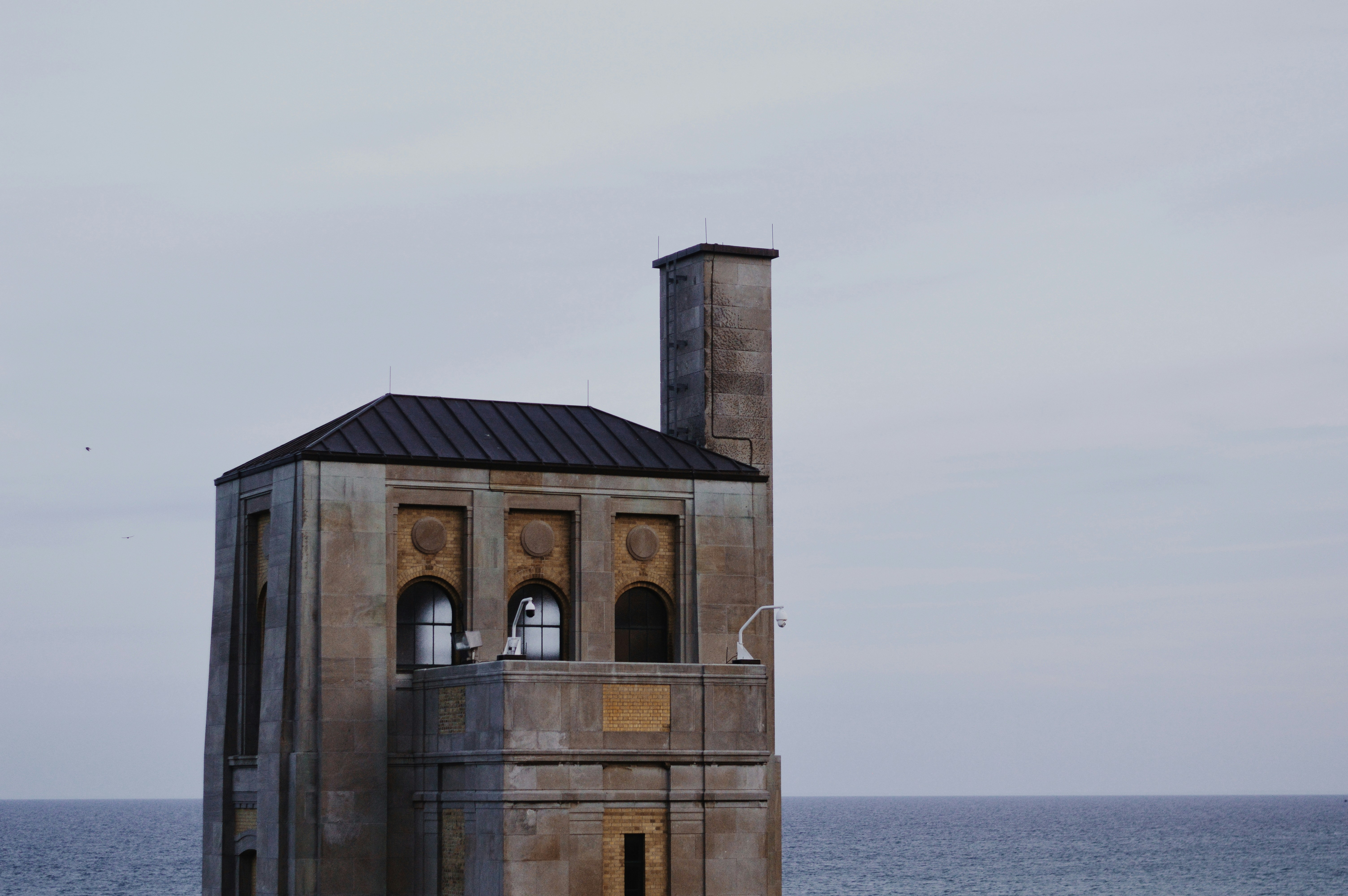 Brown concrete building near sea during daytime photo – Free Grey Image ...