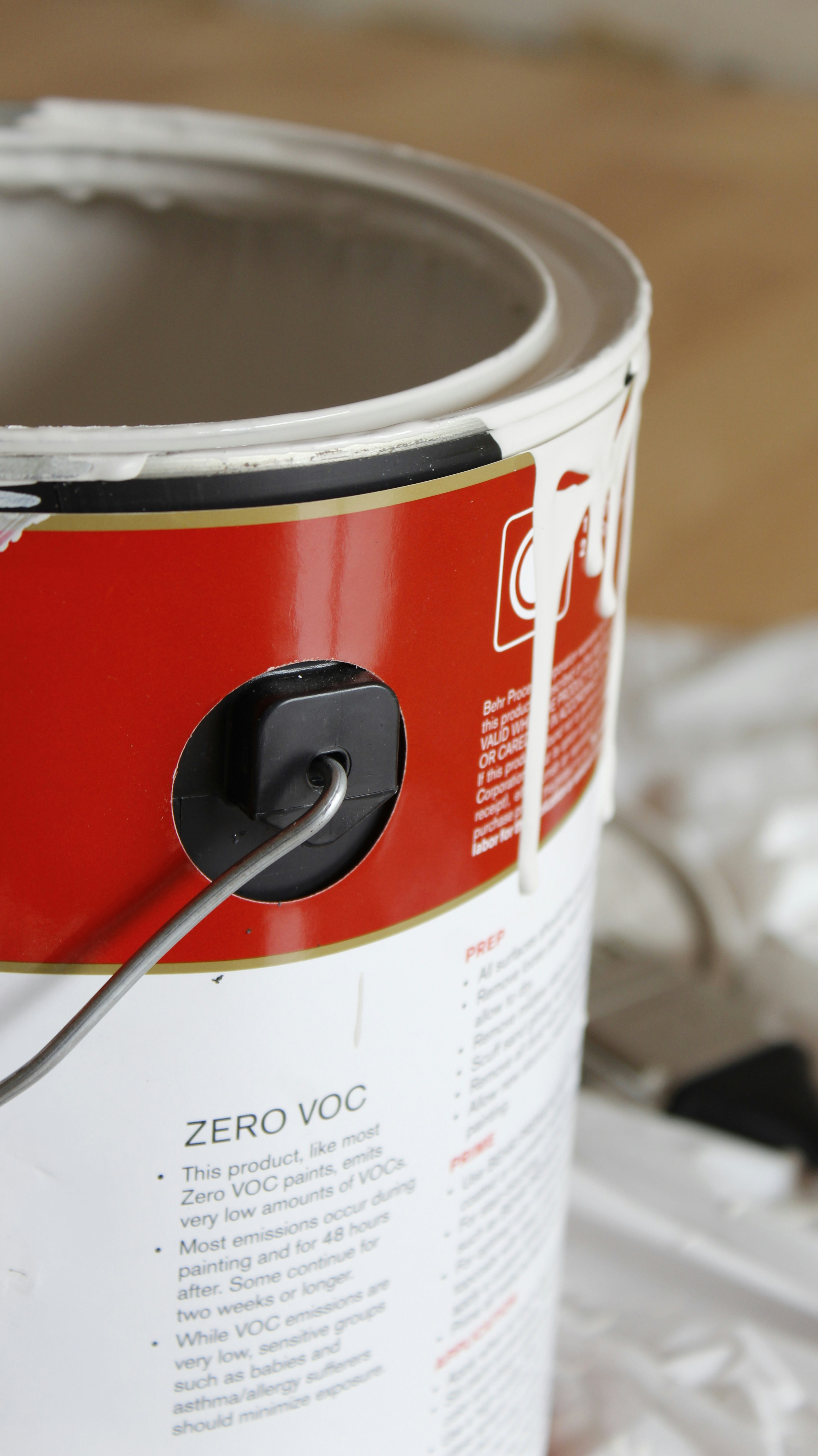 Paint Can Close-Up: White Drip and Red Label in Focus
