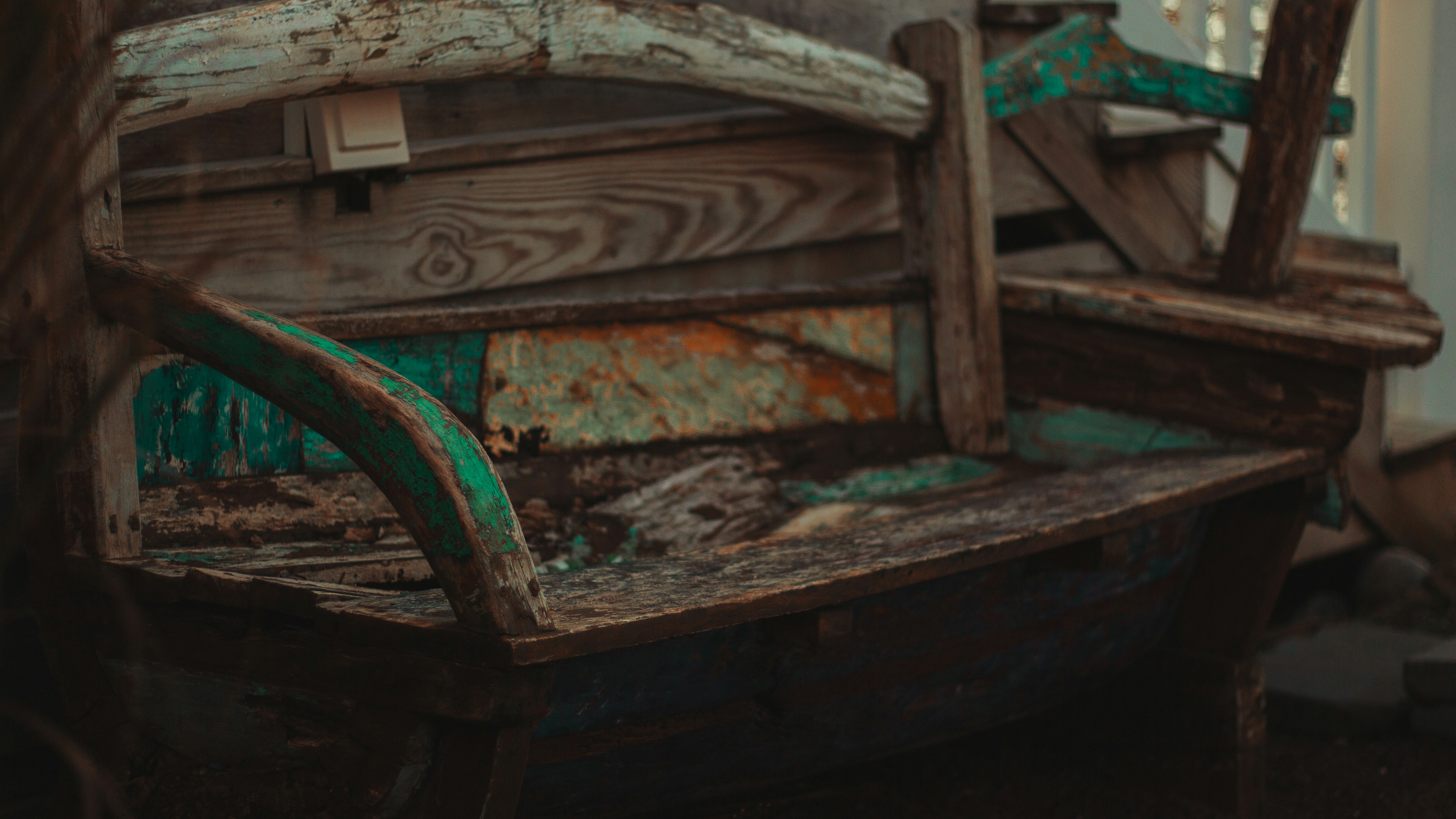 Green Curved Rail on a Timeworn Boat: Patina and Quiet Decay