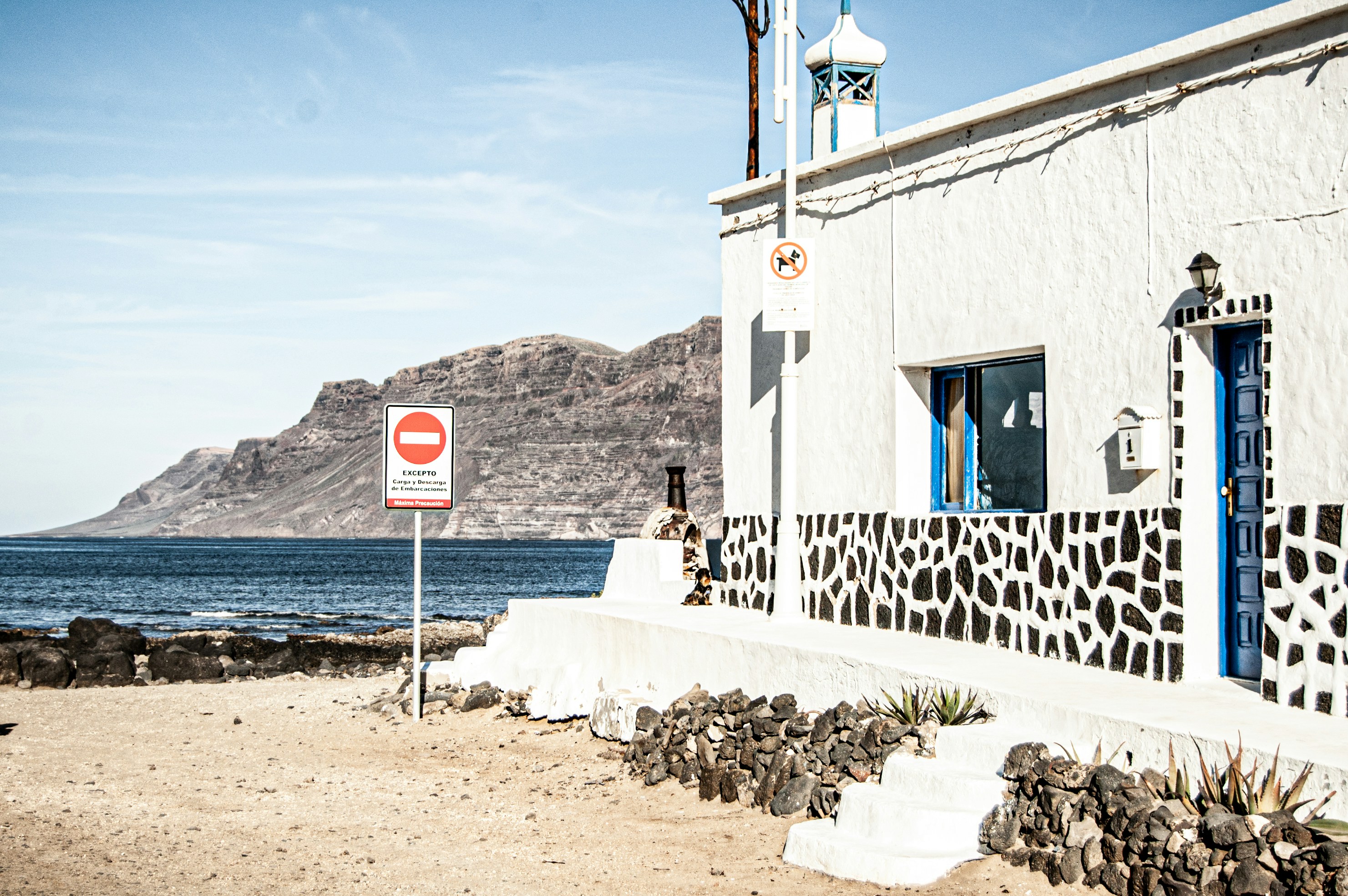 Blue Door on a Seaside White-Walled Corner