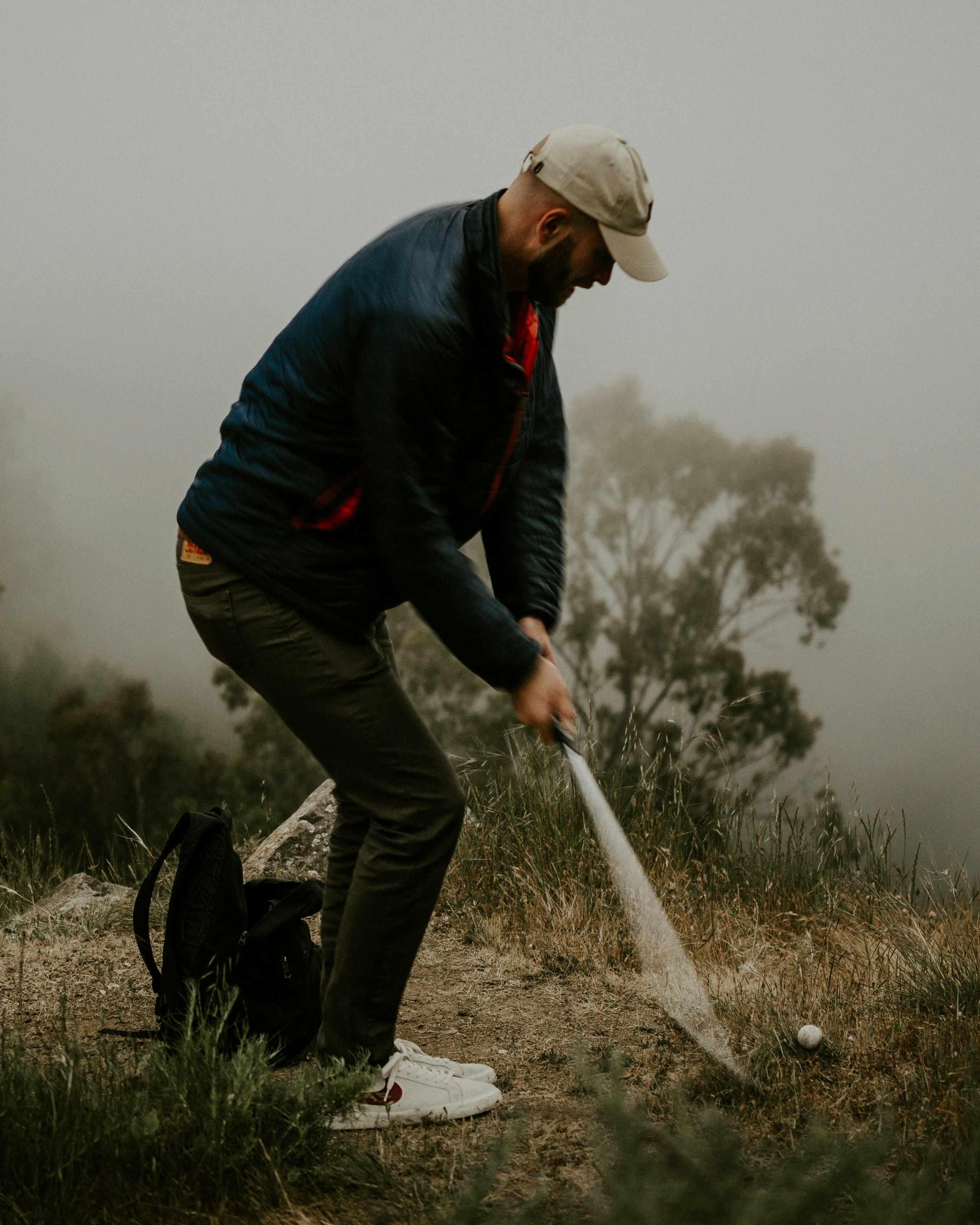 Fog-Wrapped Ridge: A Lone Golf Chip in the Mist