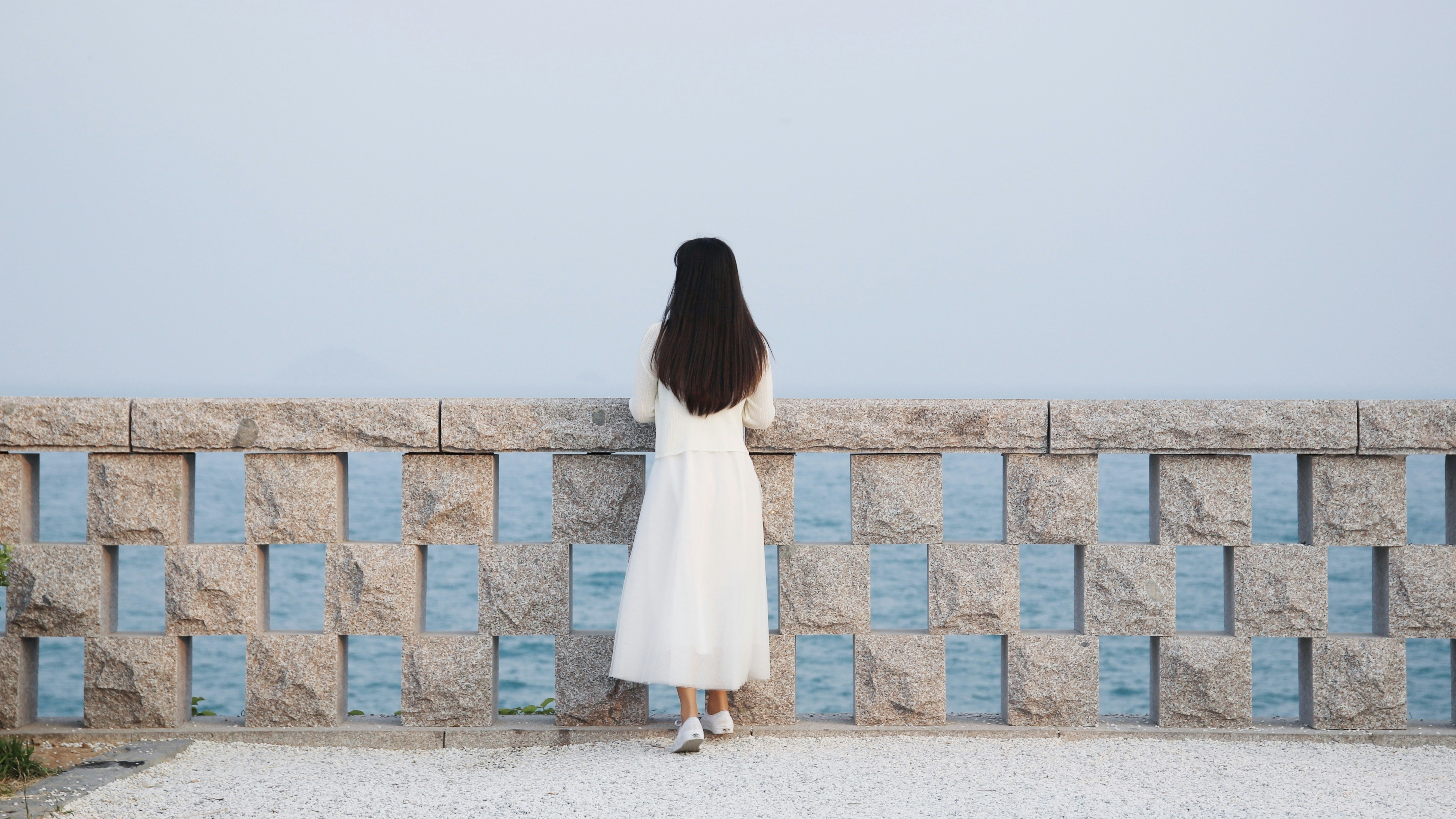 Woman in white dress standing on concrete blocks during daytime photo ...
