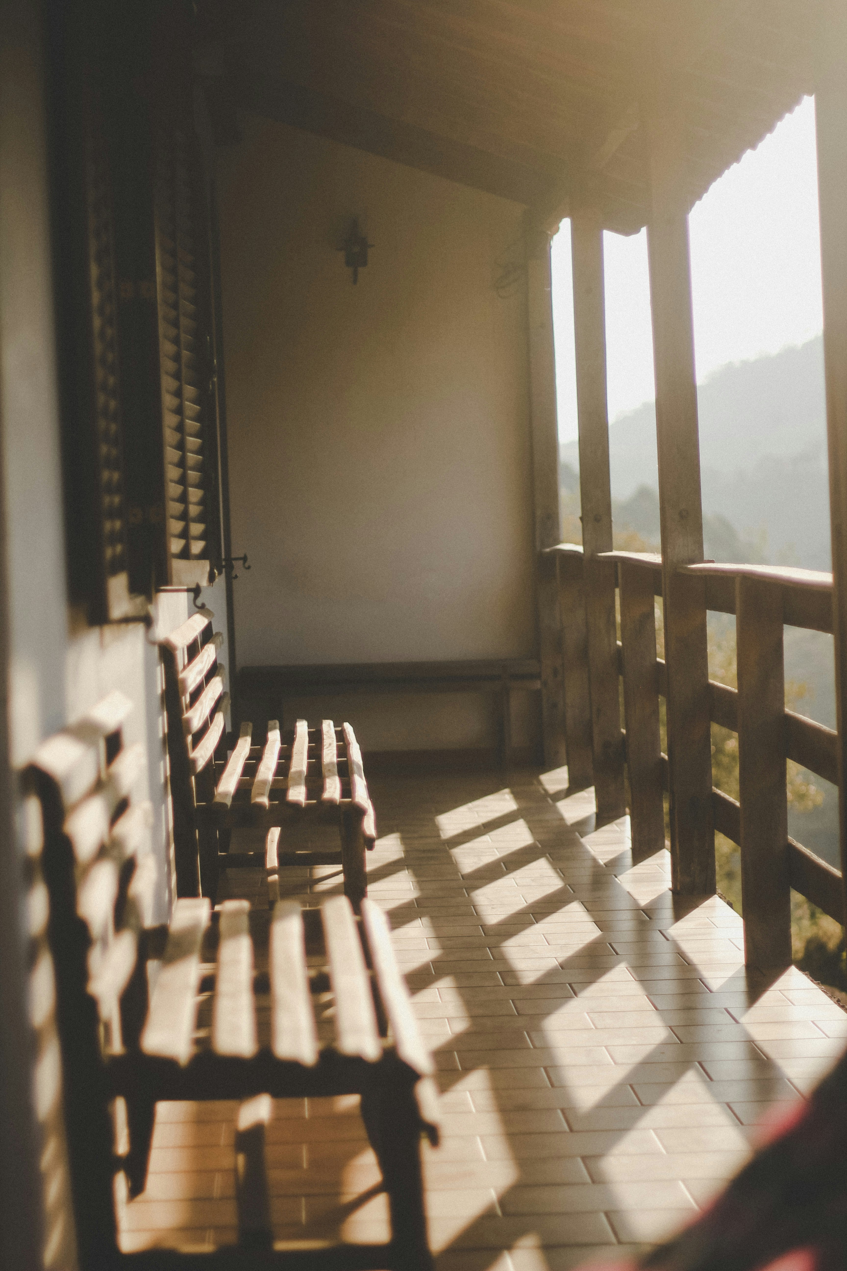 Morning Light on the Mountain Veranda: Benches, Railings, and Distant Mist