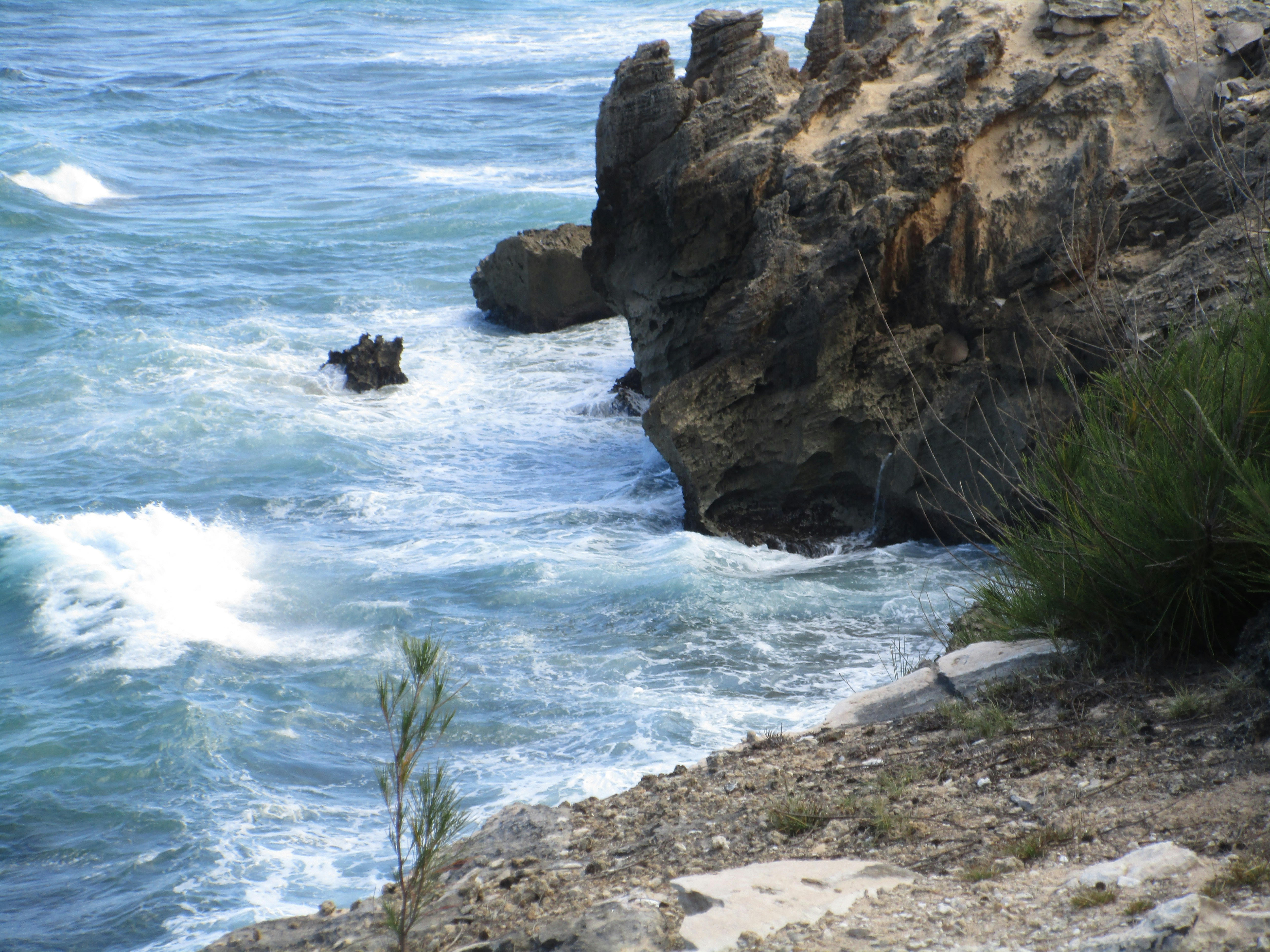Brown rocky mountain beside body of water during daytime photo – Free ...
