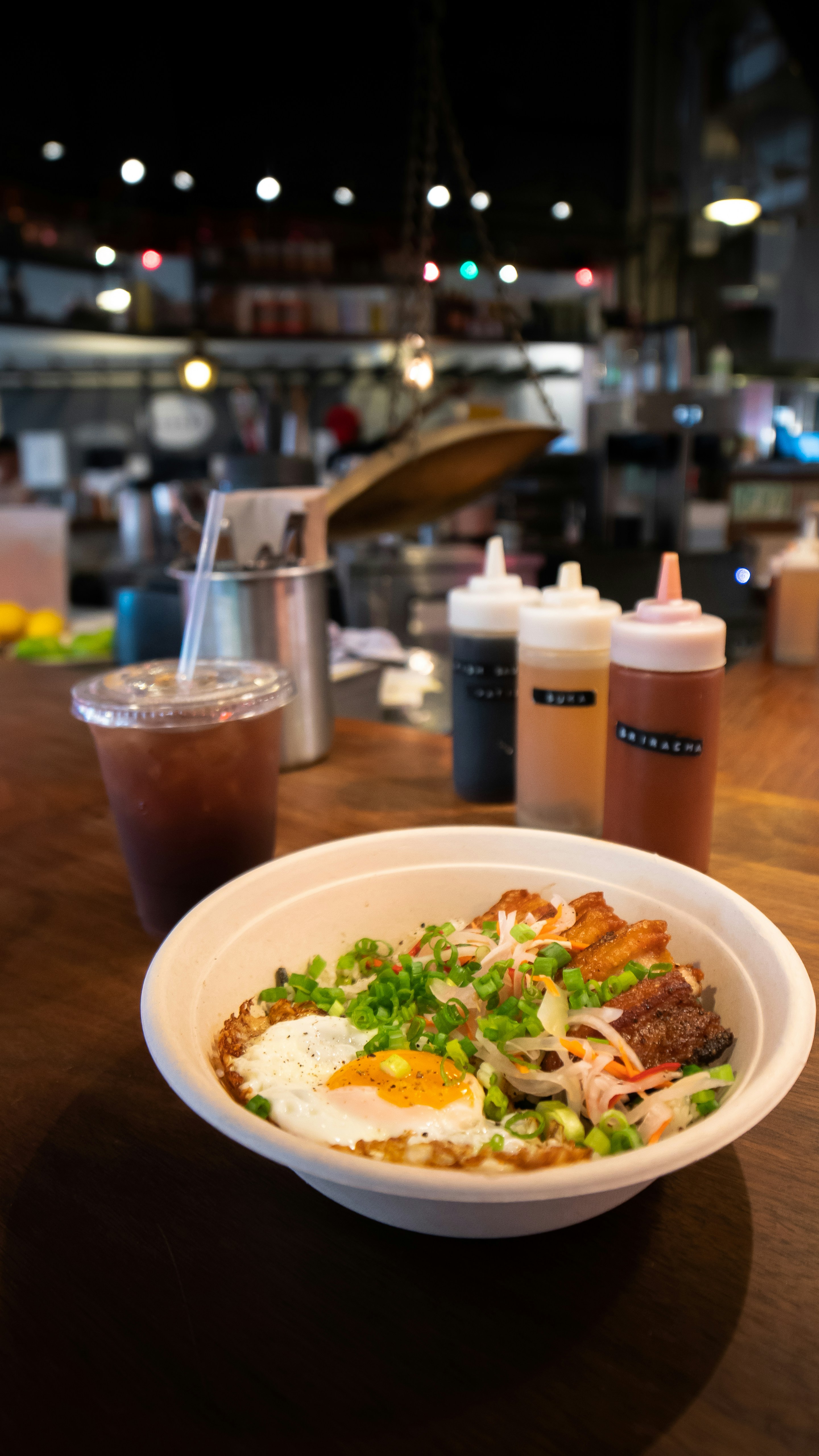 Bowl of savory goodness under warm cafe lighting