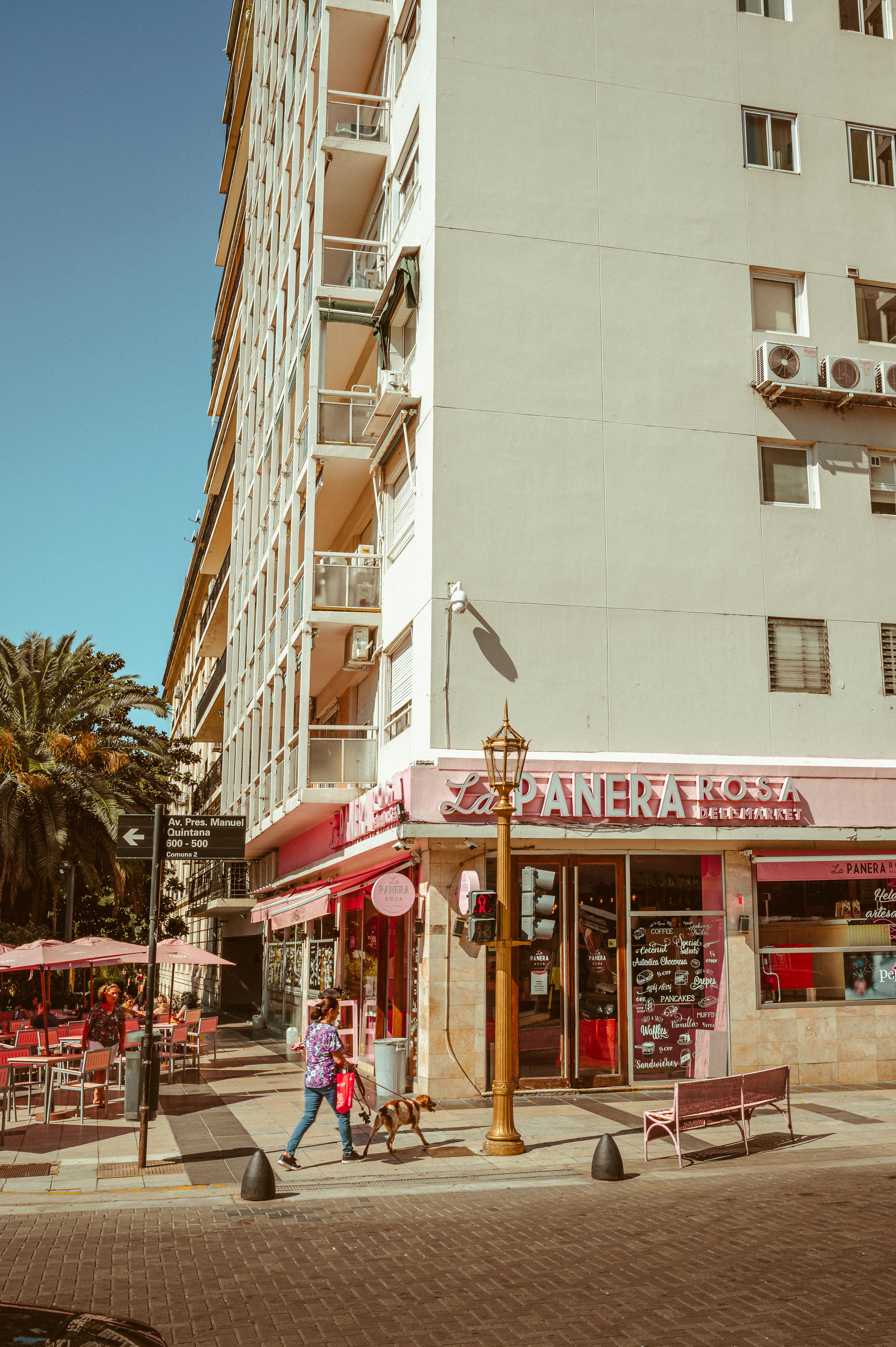 Pastel-Pink Café Anchors a Quiet Urban Corner