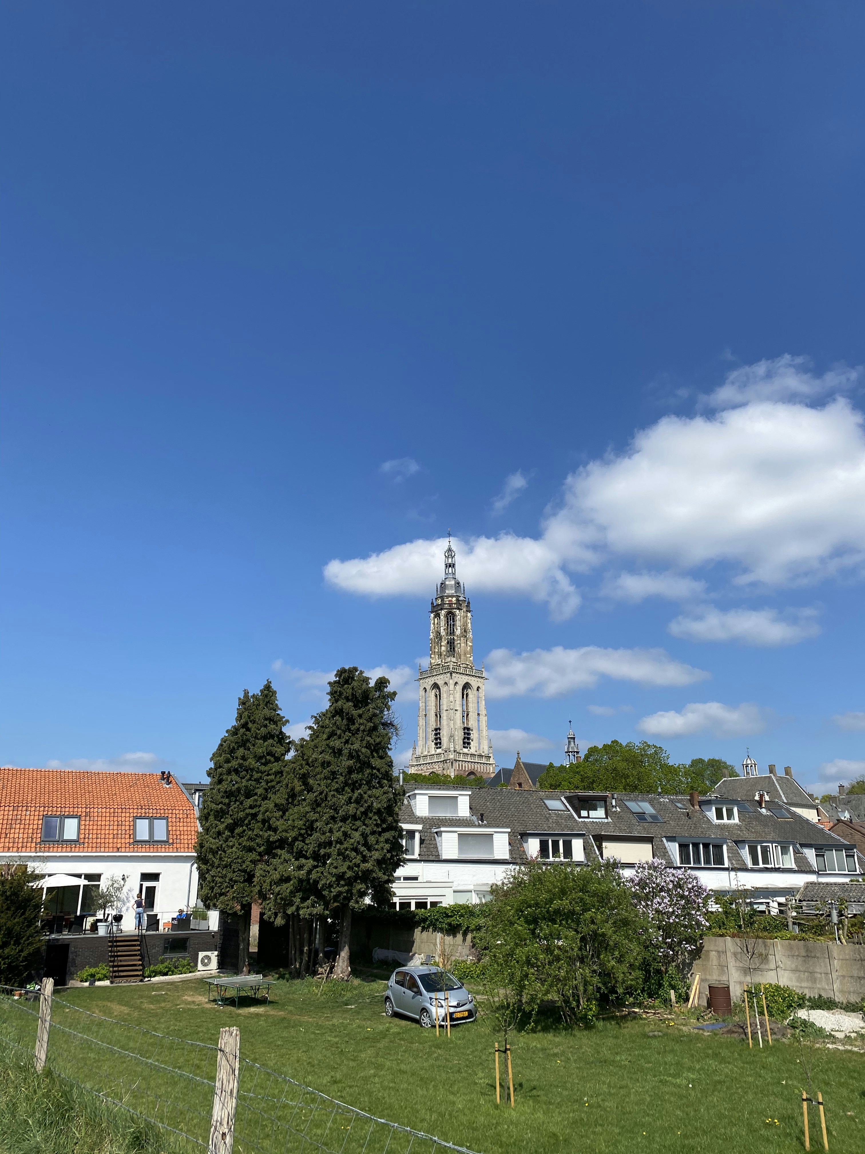 Towering Spire Above a Quiet Town Under a Pristine Blue Sky