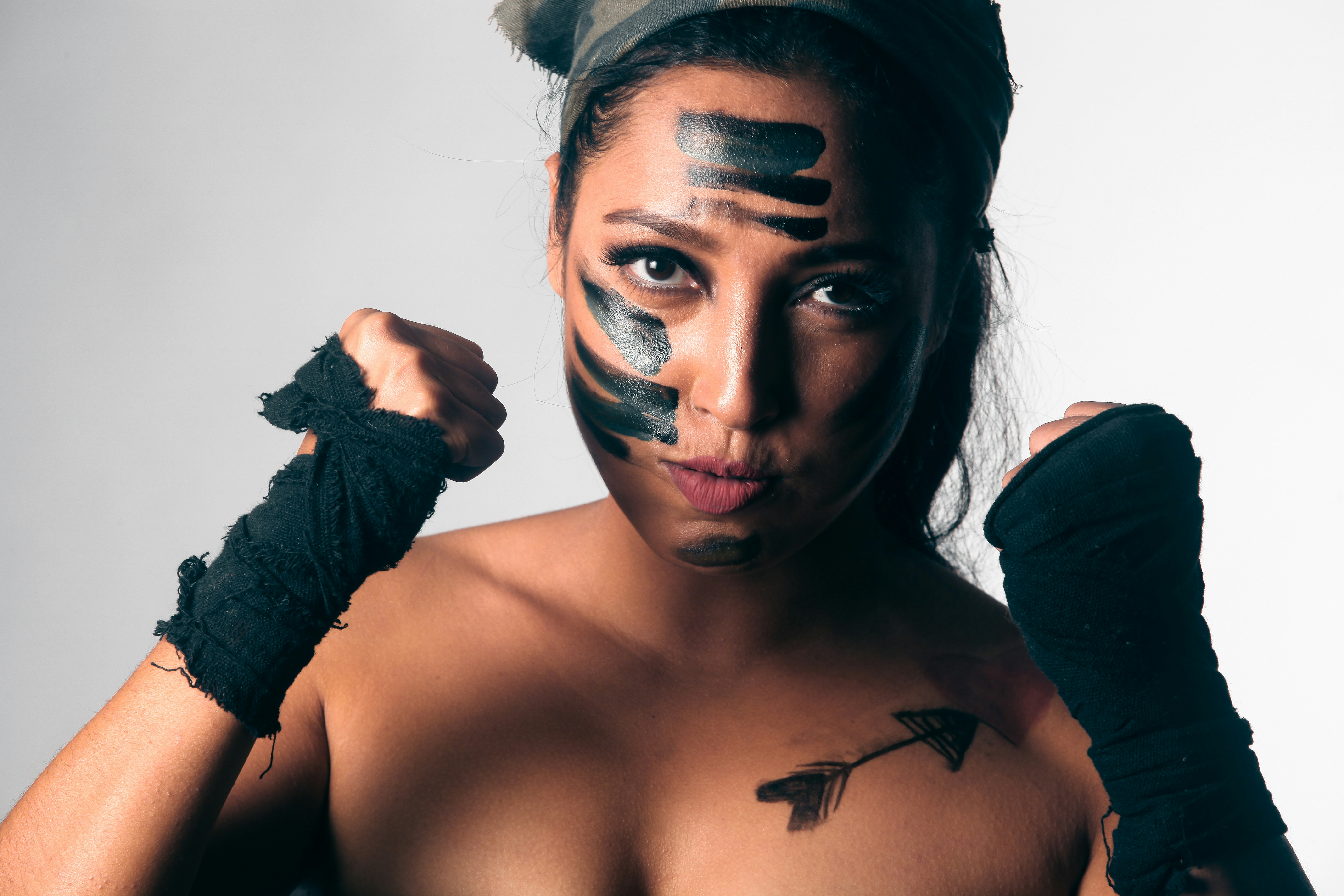 Gaze of Resolve: A Tape-Wrapped Fighter Locking Eyes in a Studio Standoff