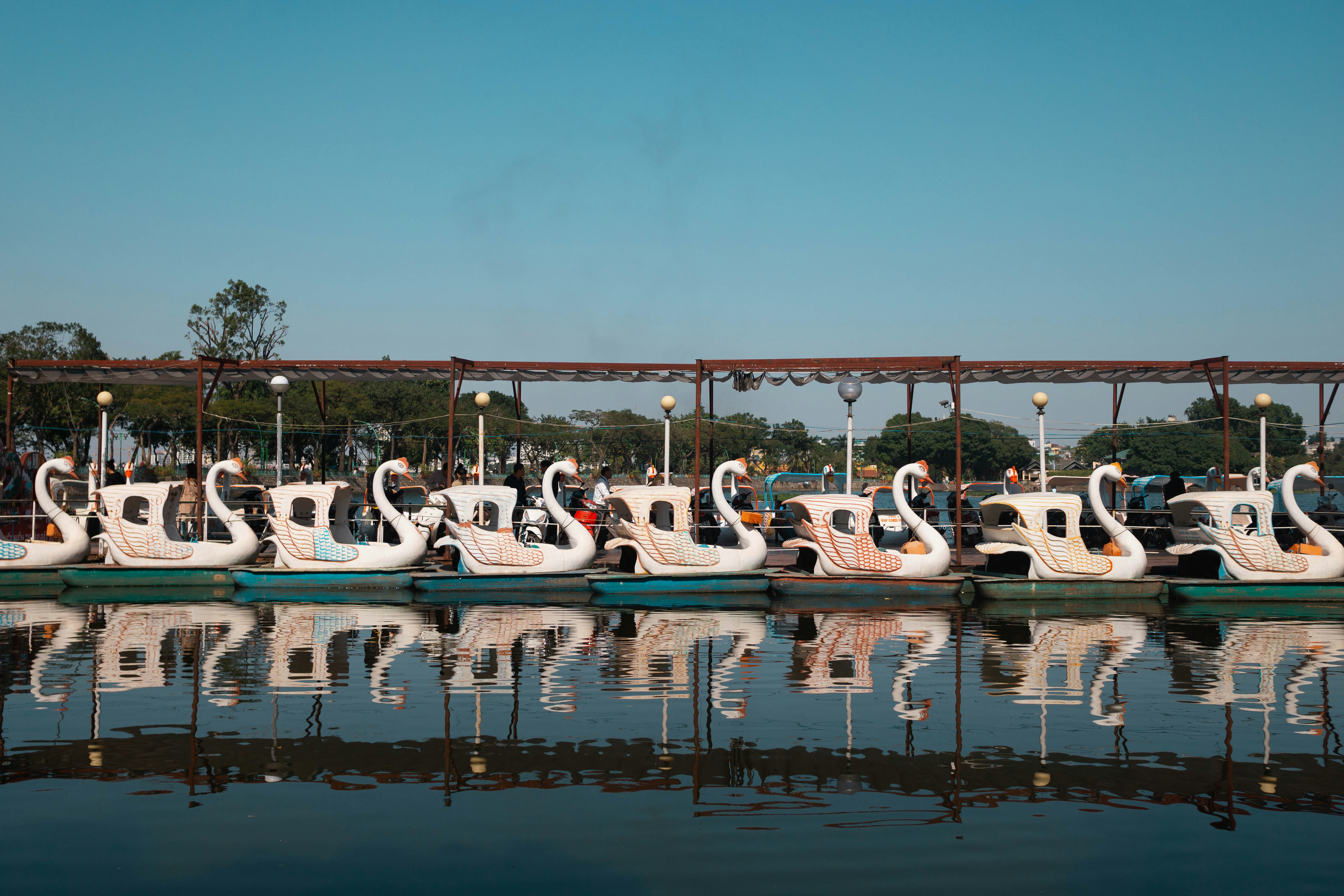people riding on white and blue boat on water during daytime