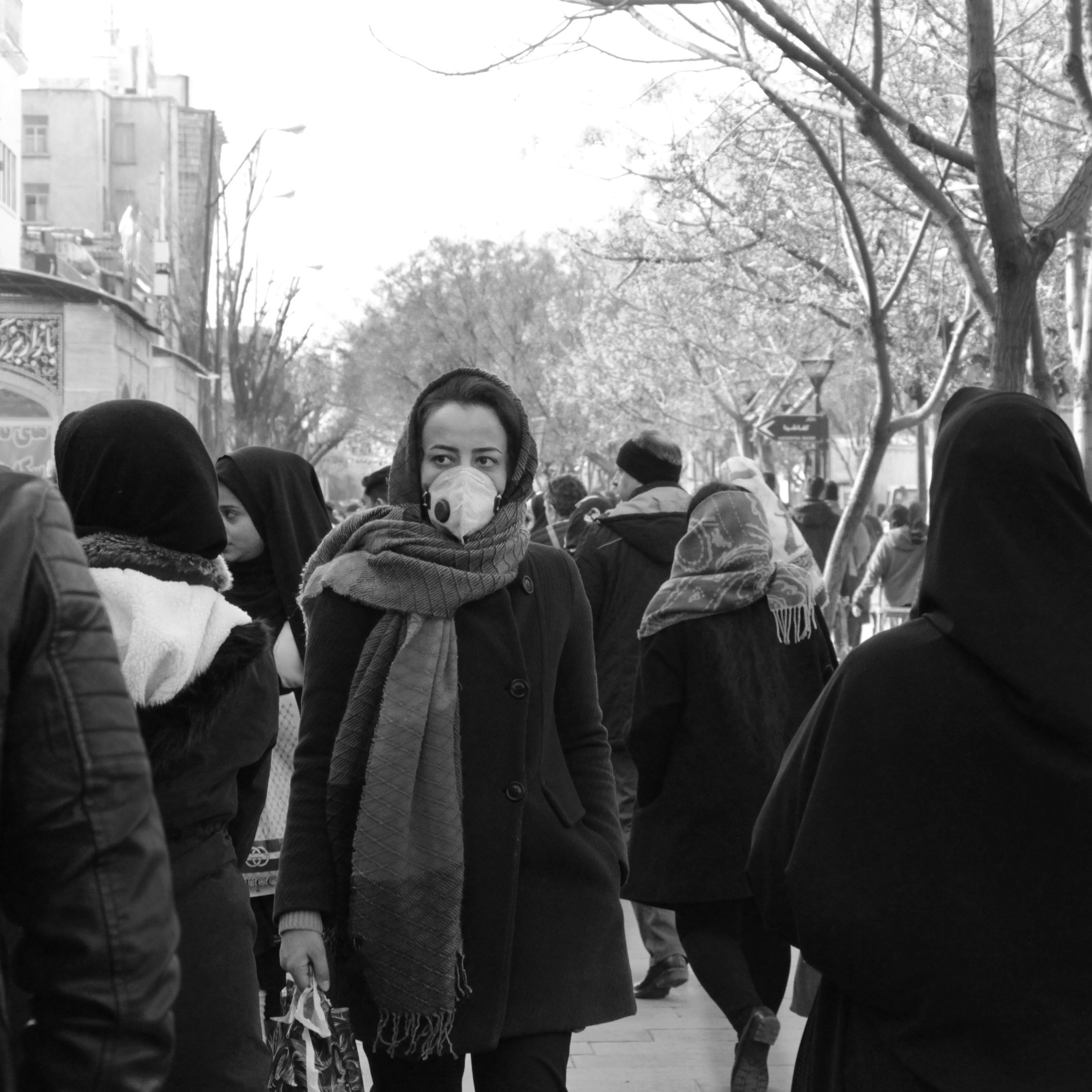 grayscale photo of people standing on snow covered ground