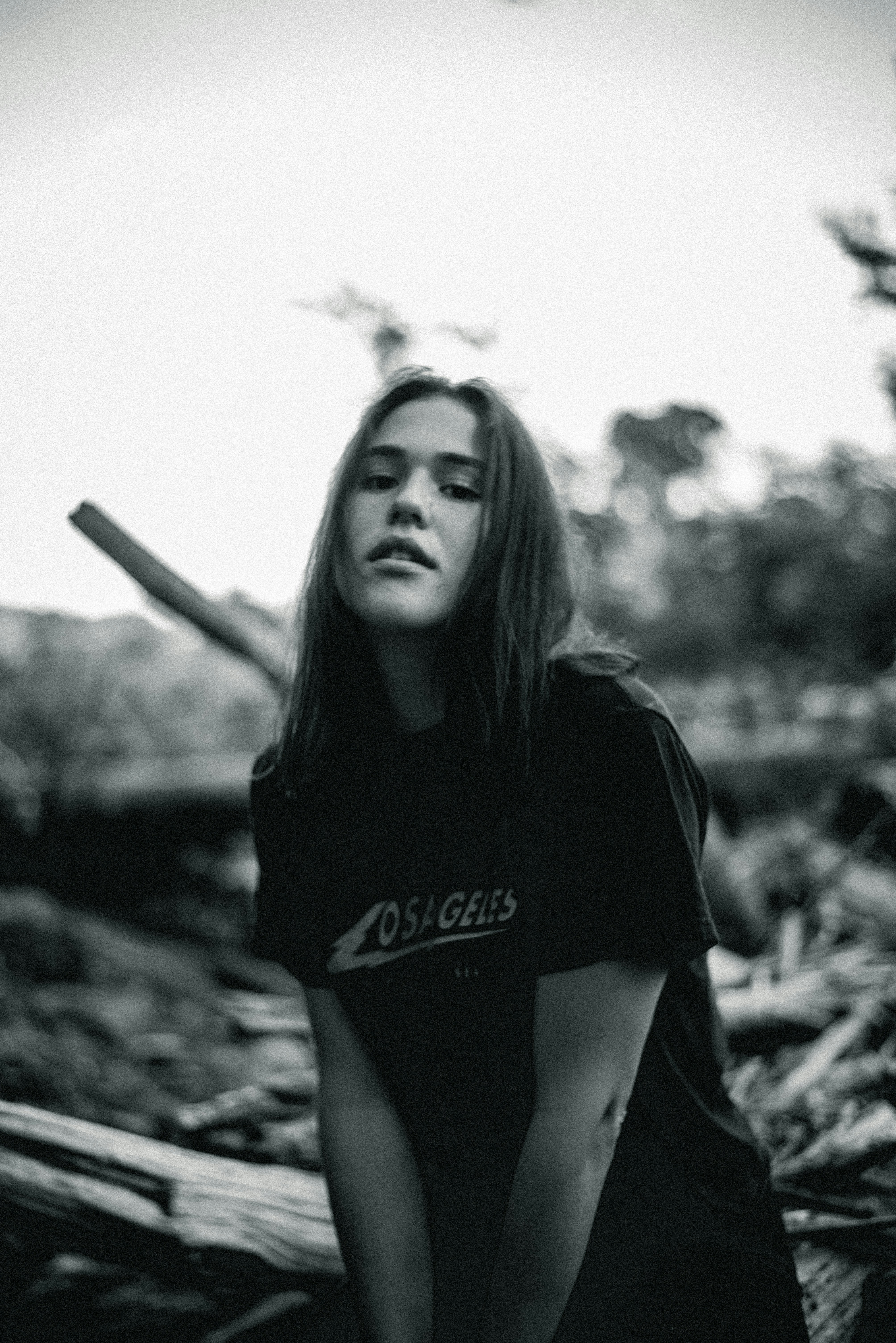 Contemplative Gaze Among Weathered Driftwood
