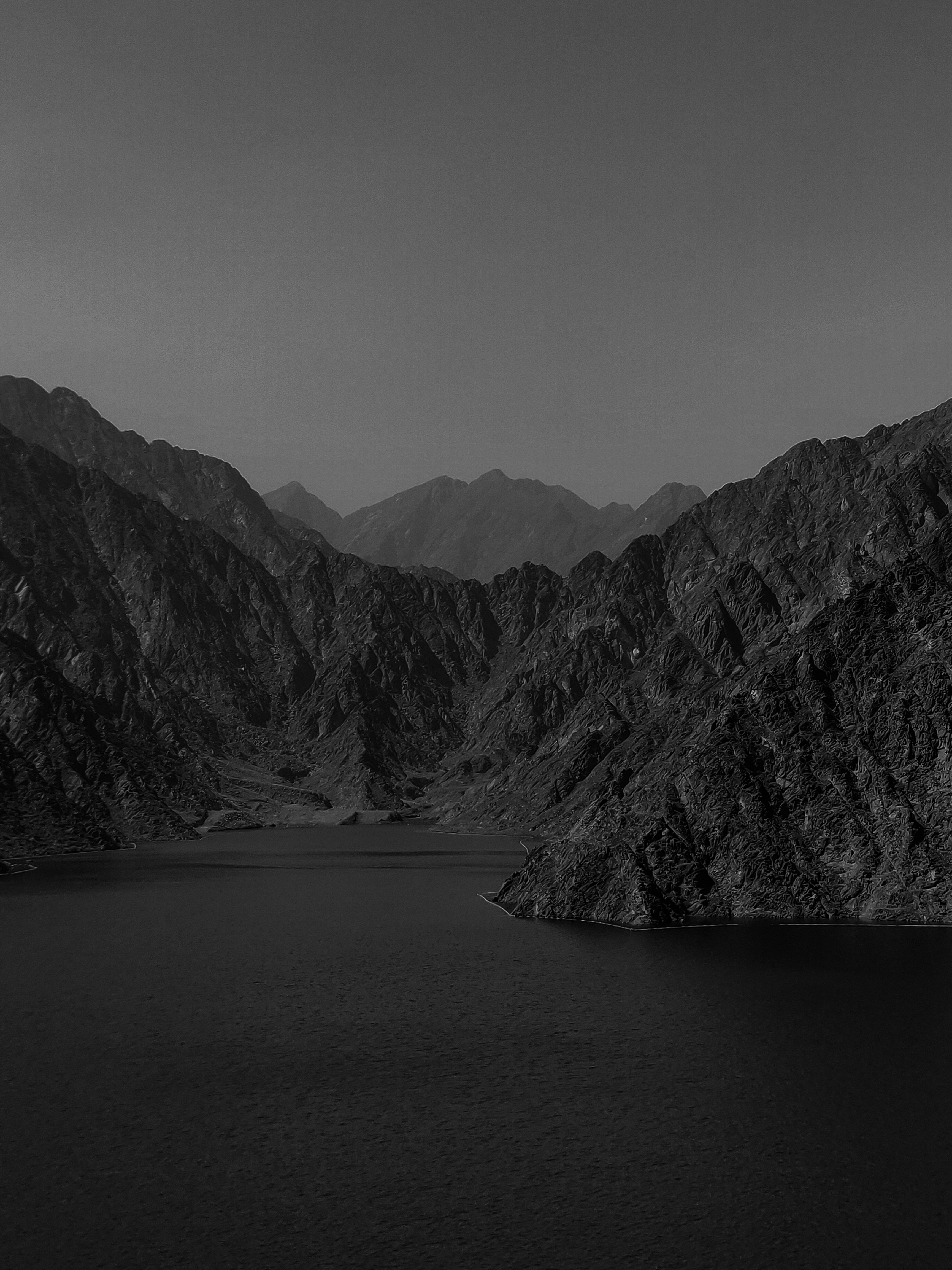 Grayscale photo of mountains near body of water photo – Free Grey Image ...