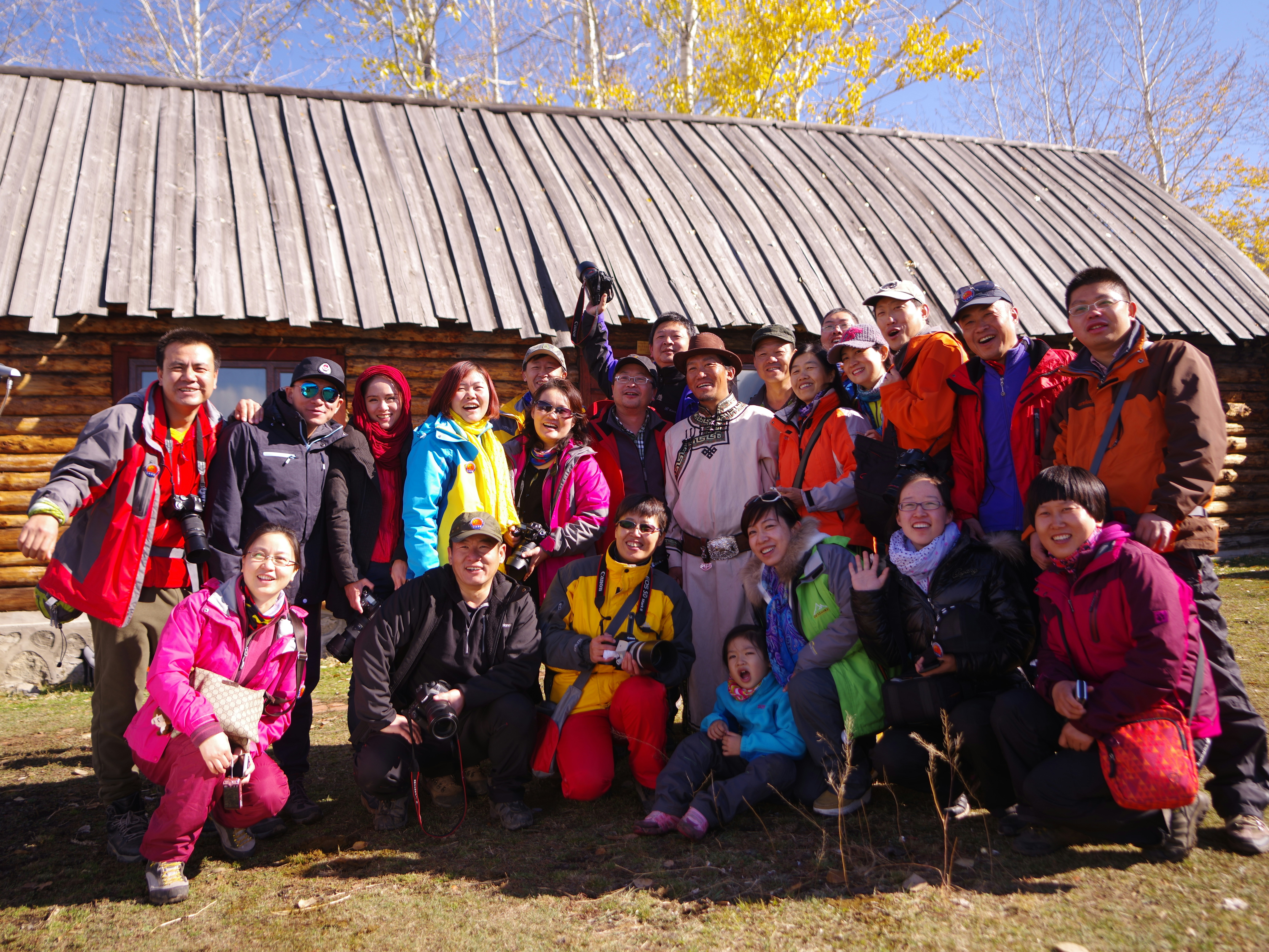 Group Portrait in Front of a Rustic Cabin