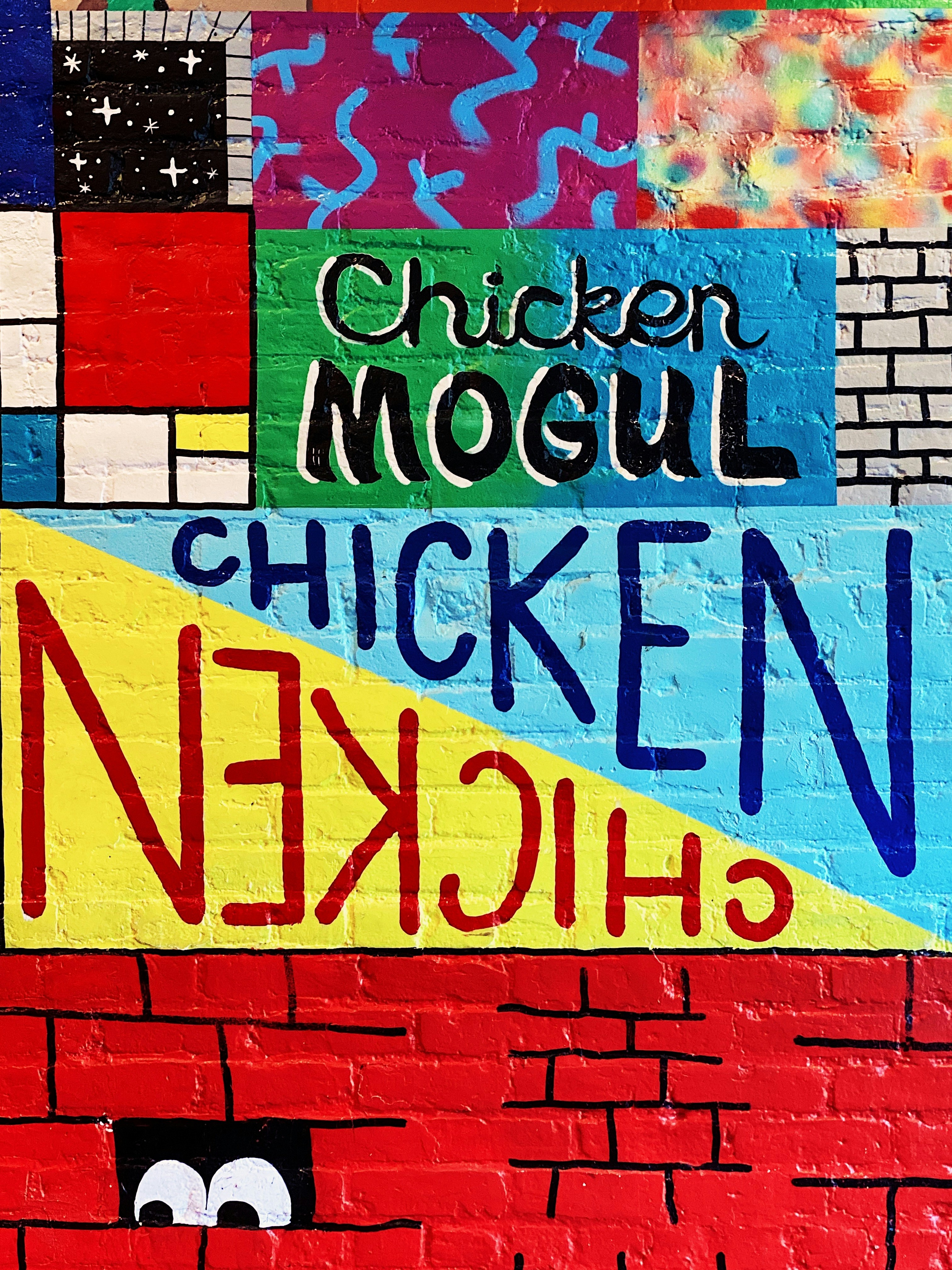 Red brick wall with blue and yellow graffiti photo – Free Chicken Image ...