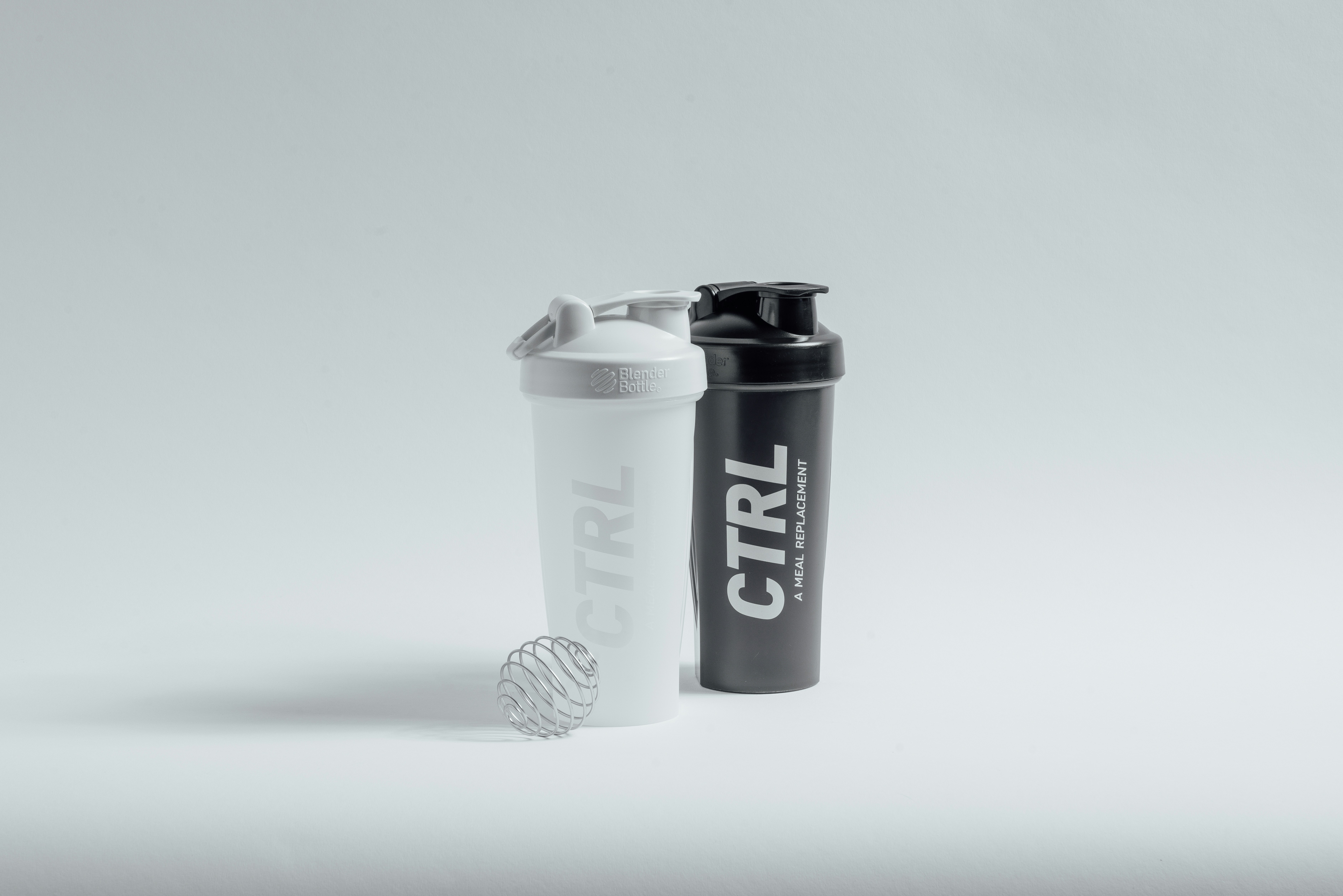 Dual Shaker Stand: White and Black Bottles with a Mesh Ball