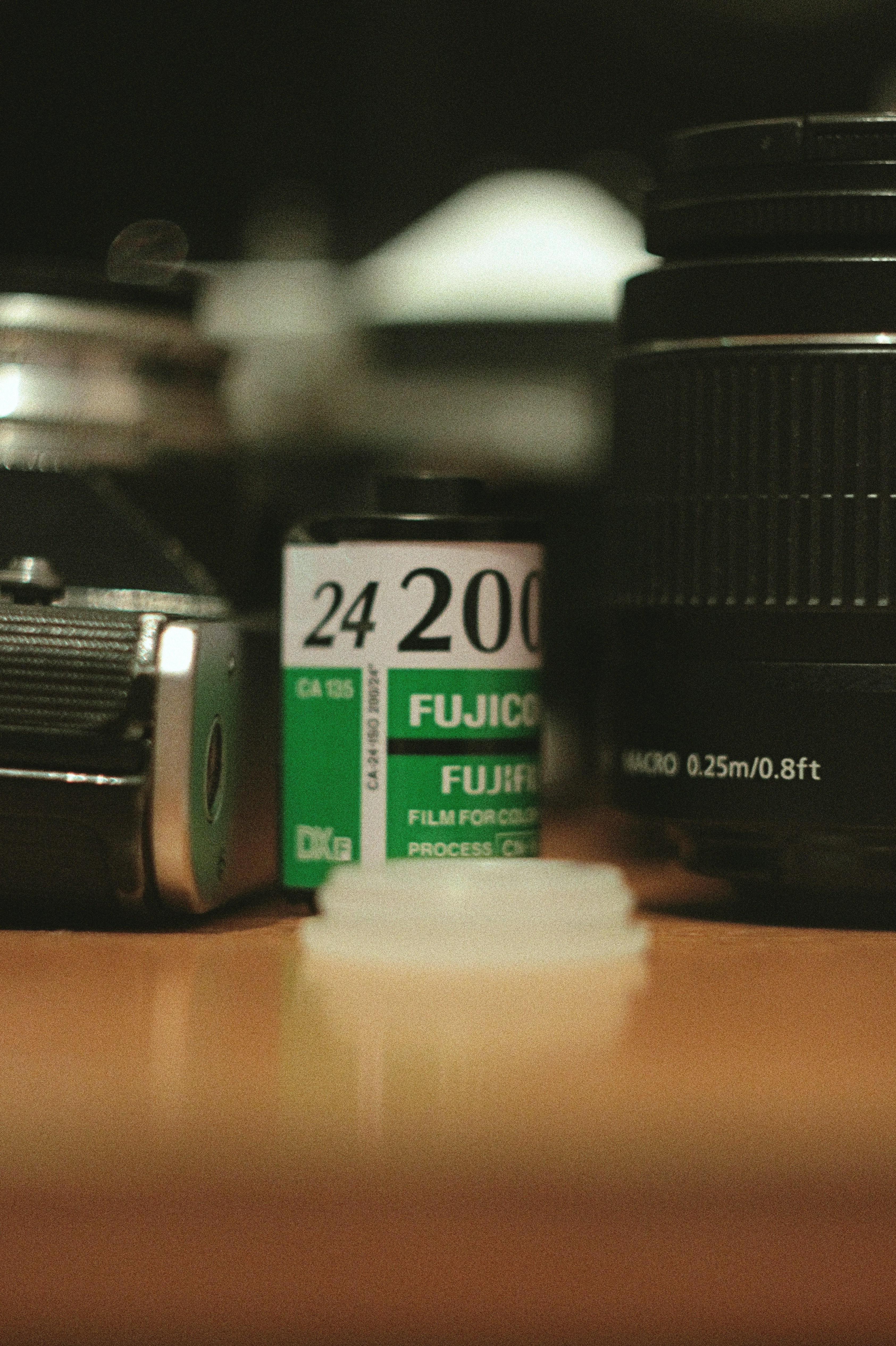 Between Gear and Glass: Fuji 200 Nestled Between Lenses