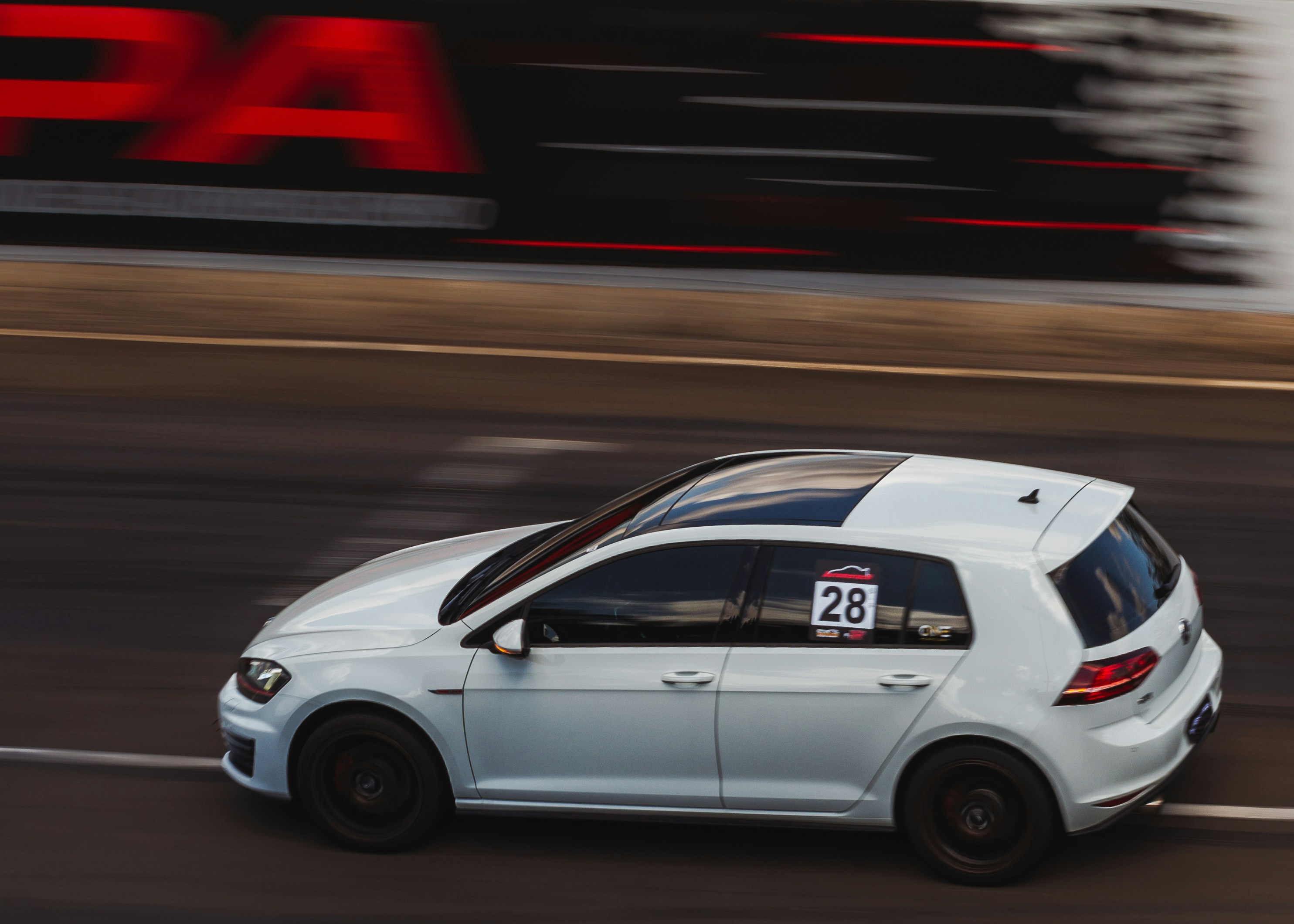 Tracking a White Hatchback: A Sprint Through Motion Blur on the Track