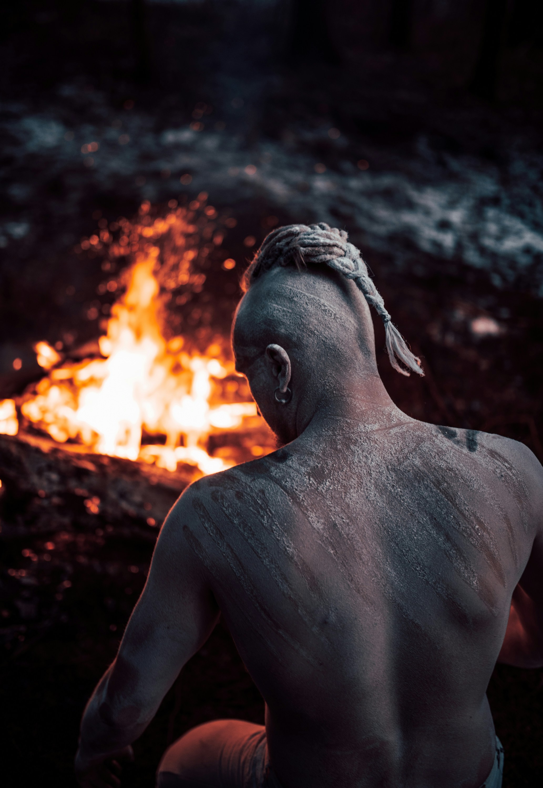 Backlit by Fire: The Shaved-Pate Sentinel with Braided Dreads