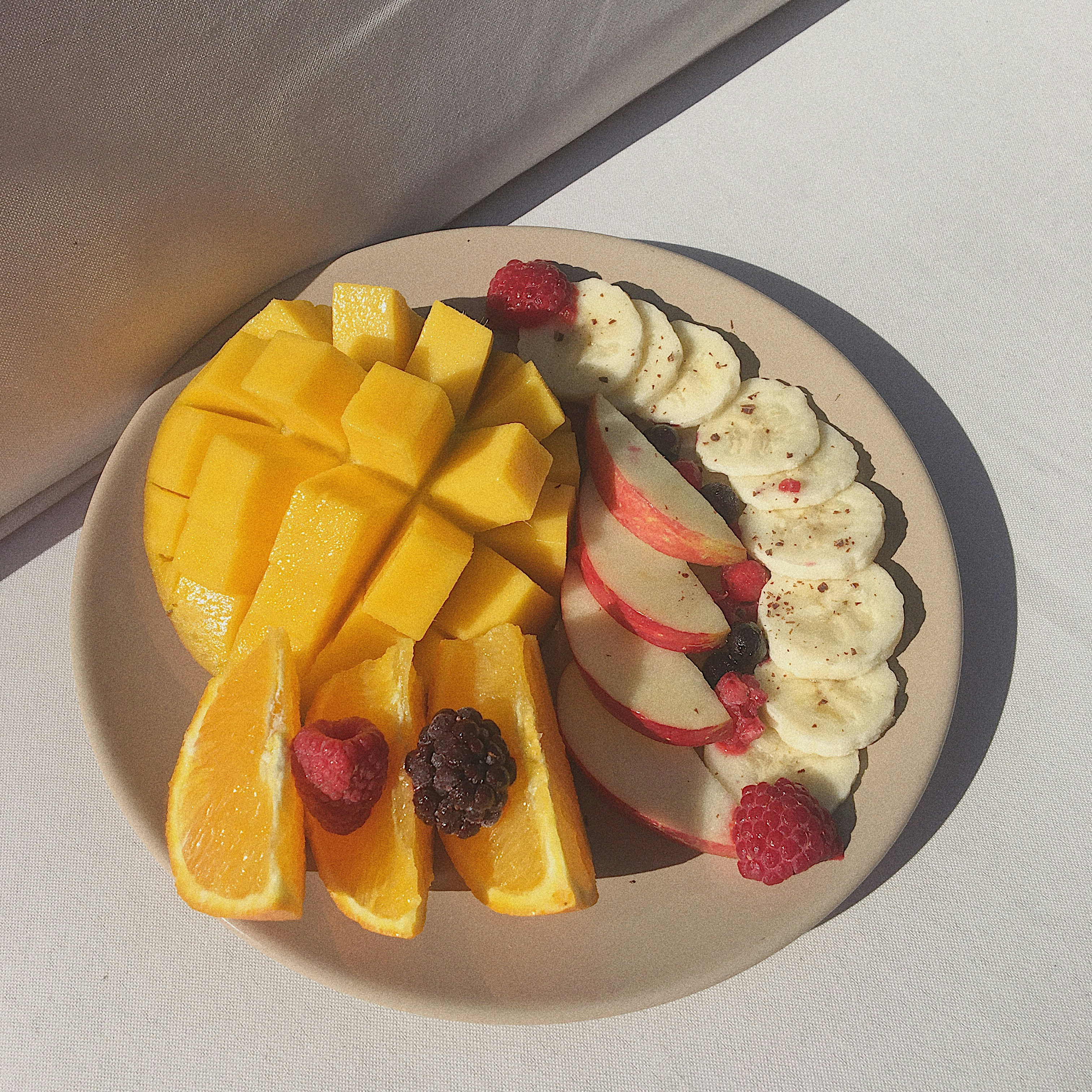 A Sunlit Platter of Mango, Citrus, and Berries