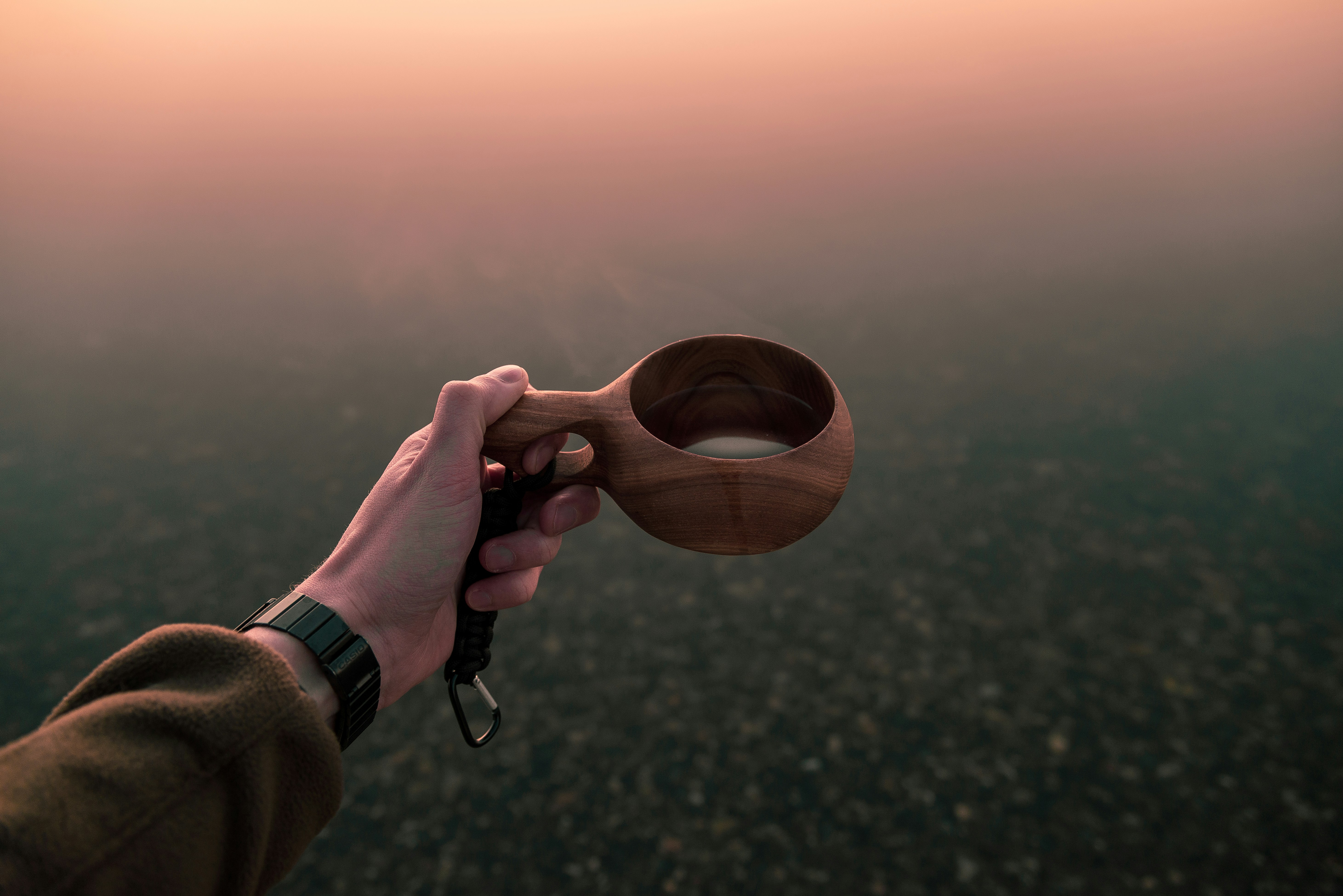 First Light Through a Handheld Wooden Spyglass Over a Distant Valley