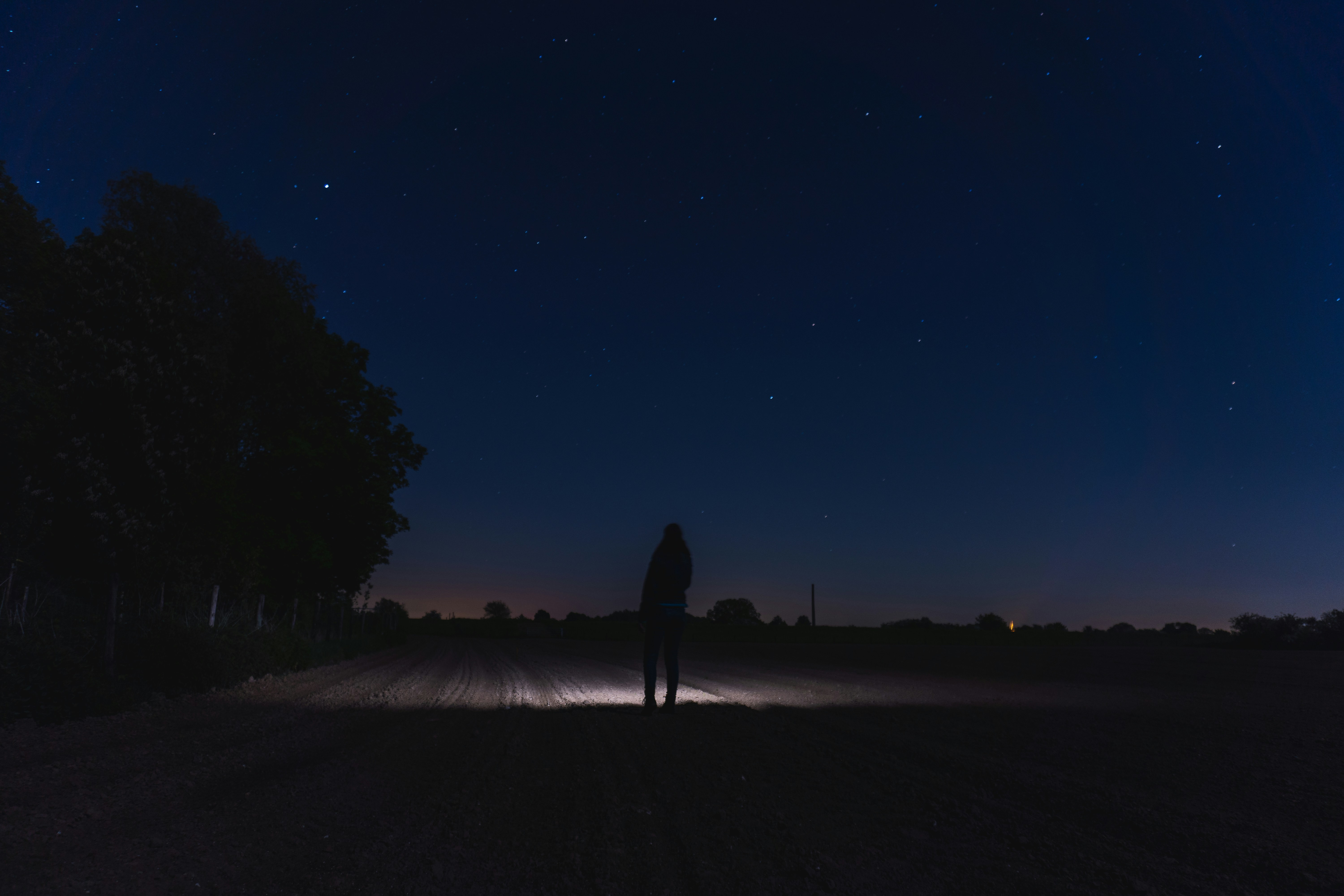 Silhouette of person walking on sand during night time photo – Free ...