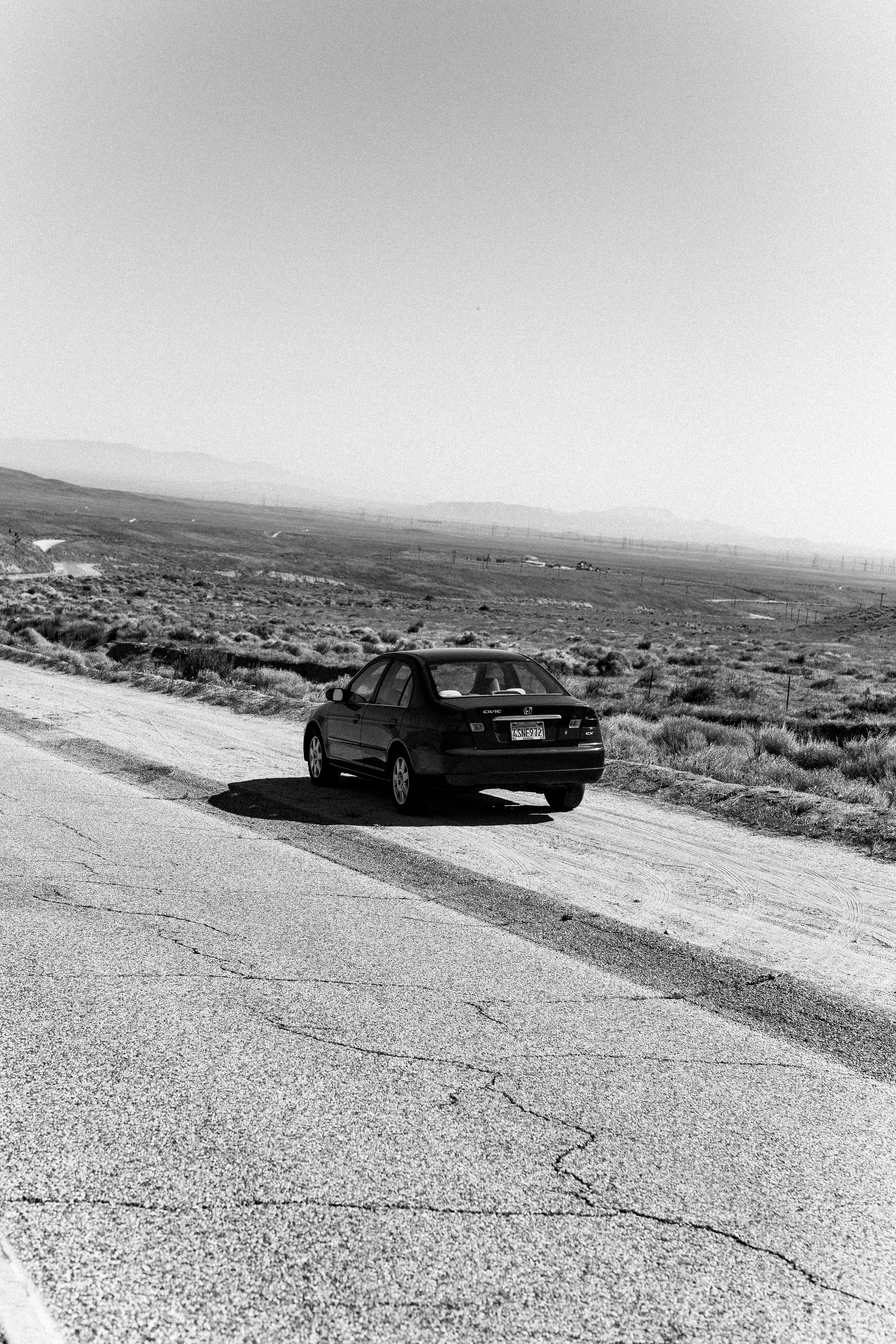 grayscale photo of car on road