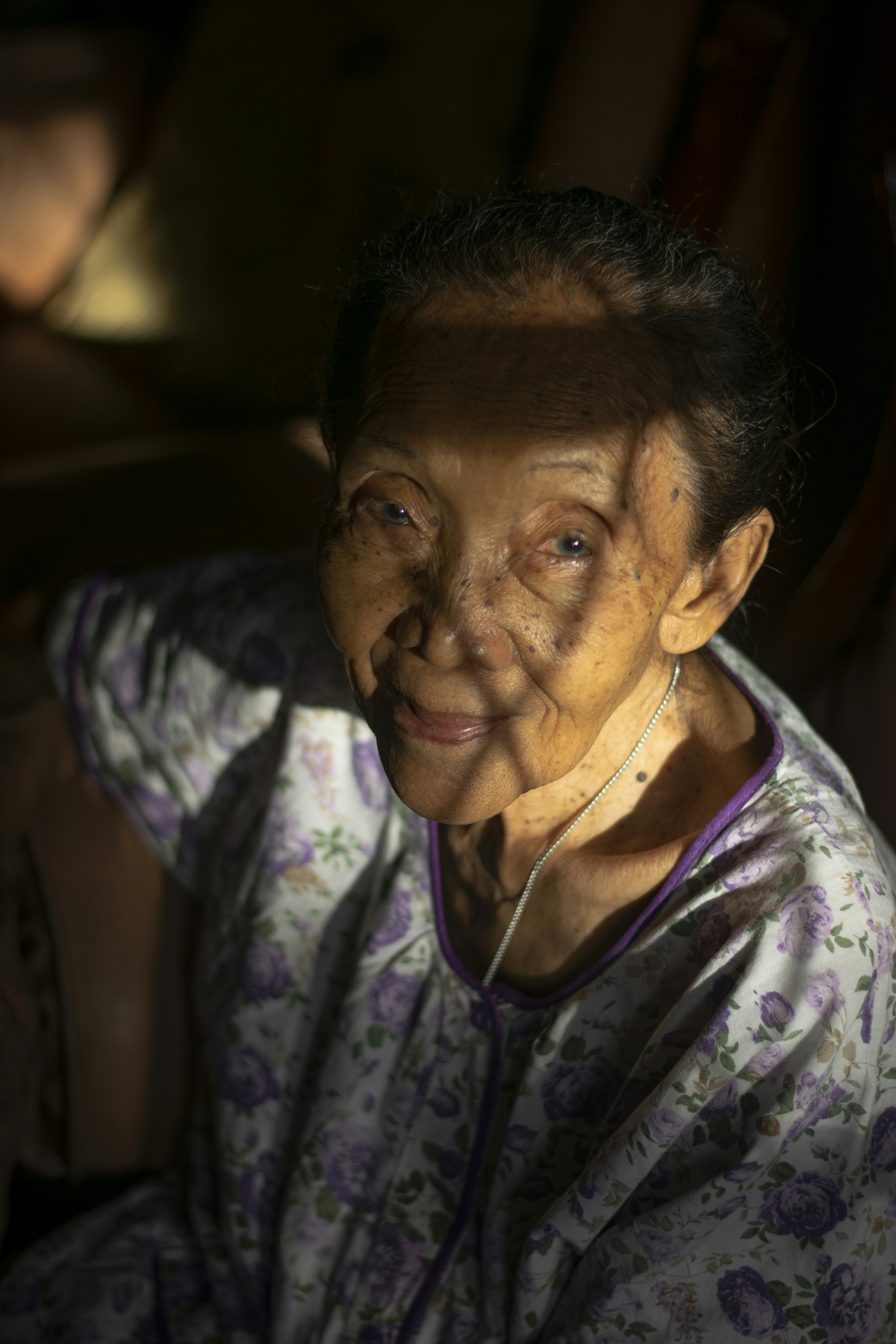 Whispers of Light: A Grandmother's Portrait in a Shadowed Room