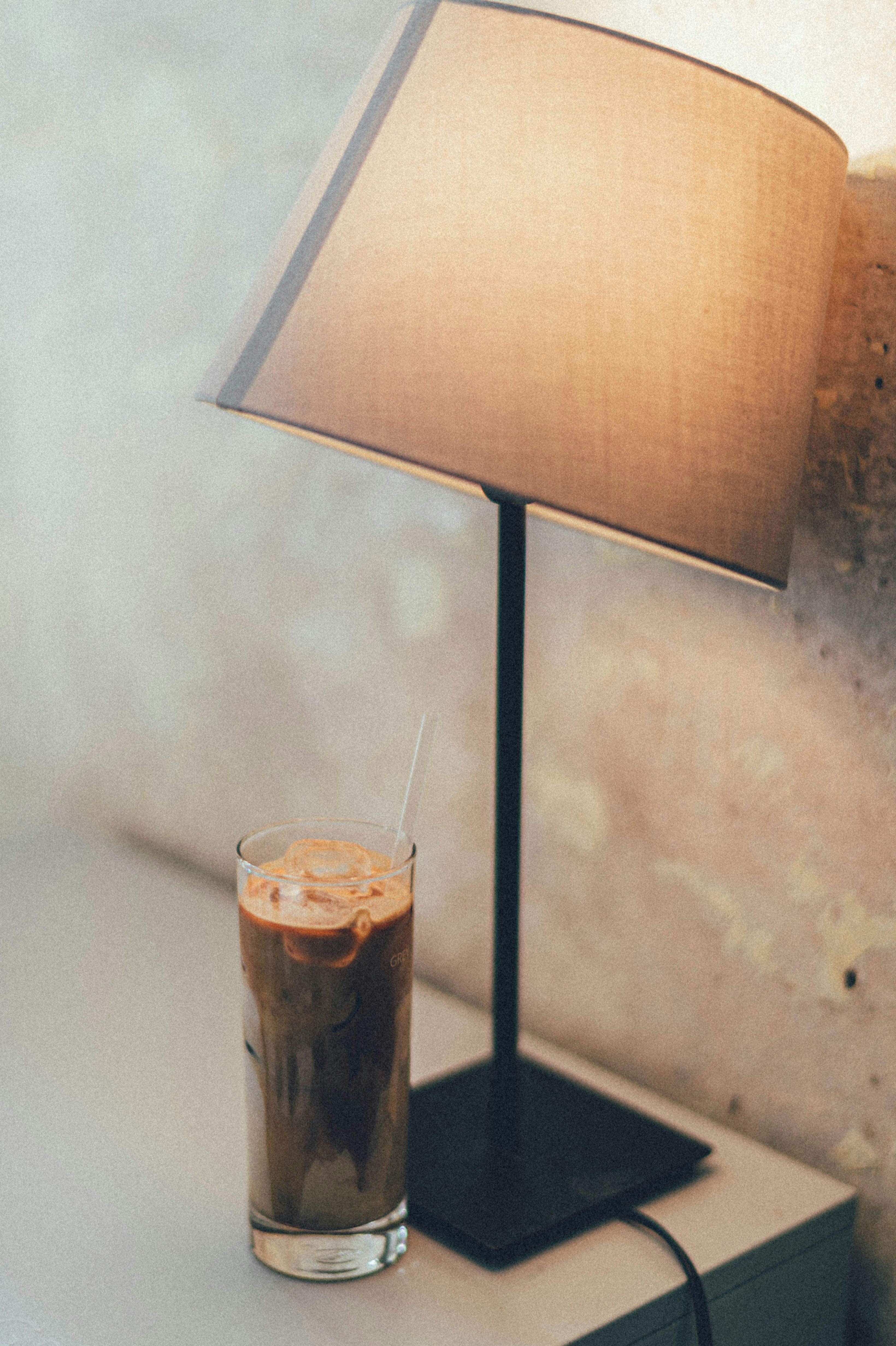 Warm Quiet: Latte Beside a Lamp in Soft Focus