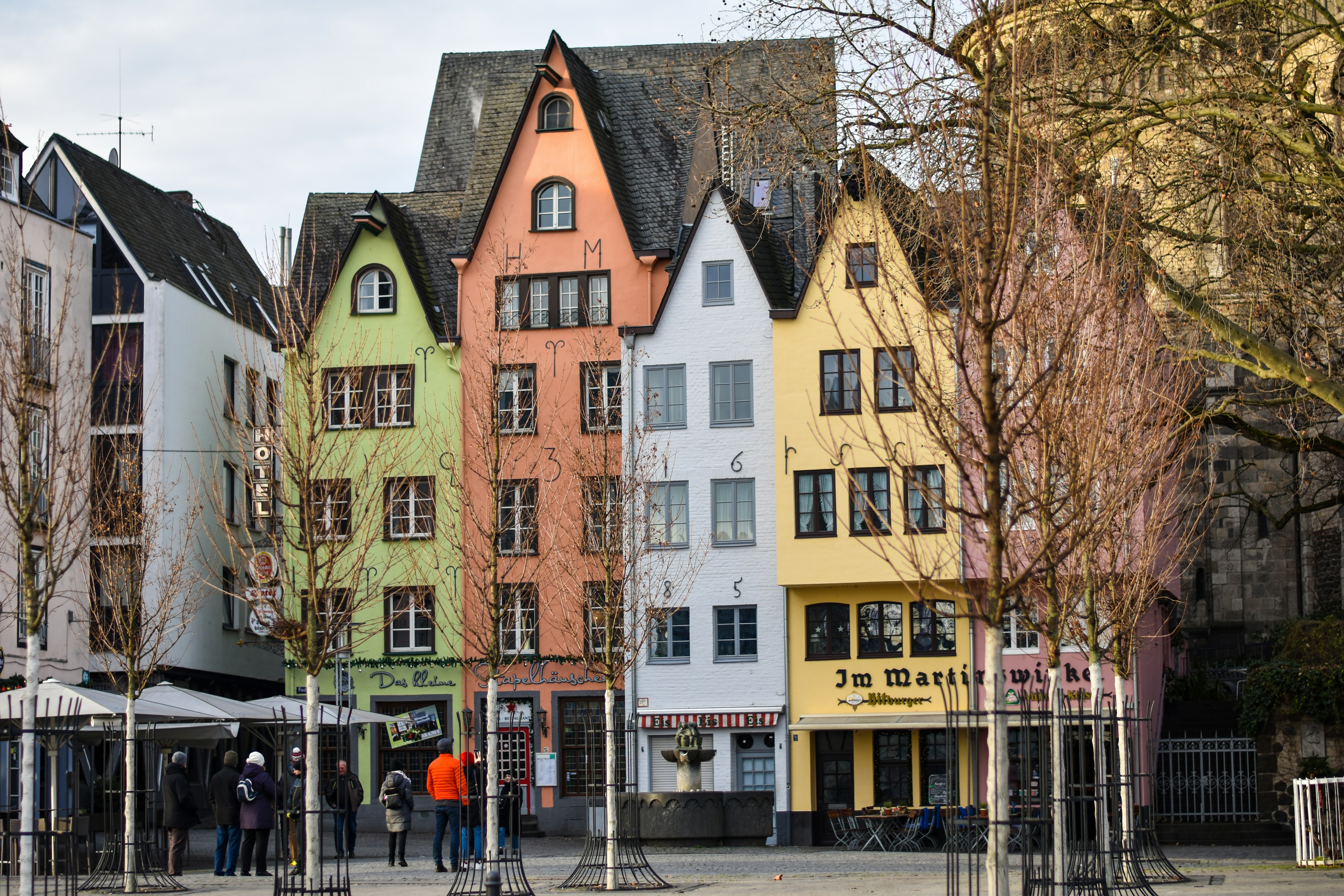 Pastel Parade Along a Sunlit European Street