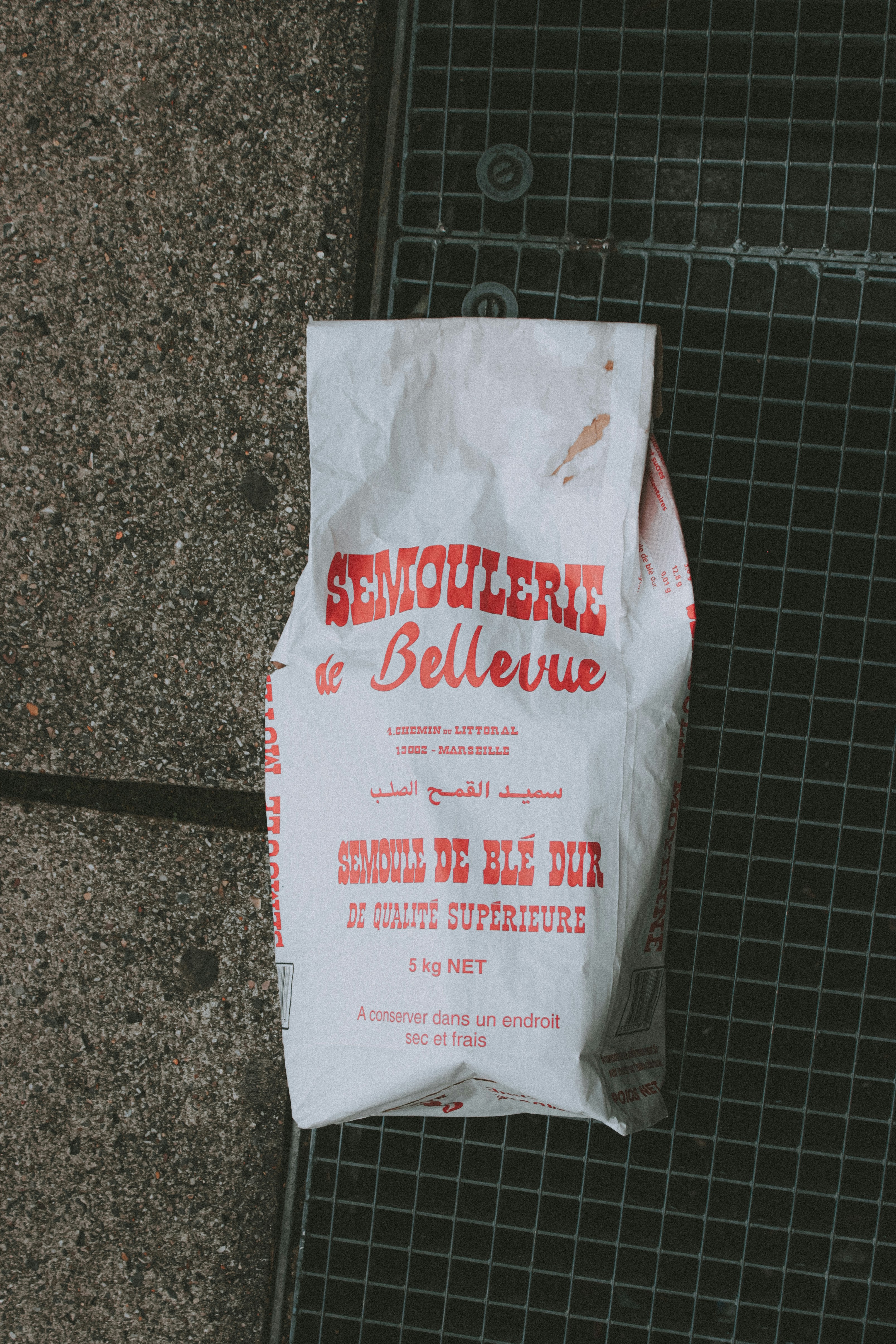 A vintage semolina bag resting on a textured surface, showcasing its distinctive typography and branding. The bag emphasizes quality and heritage in grain production.