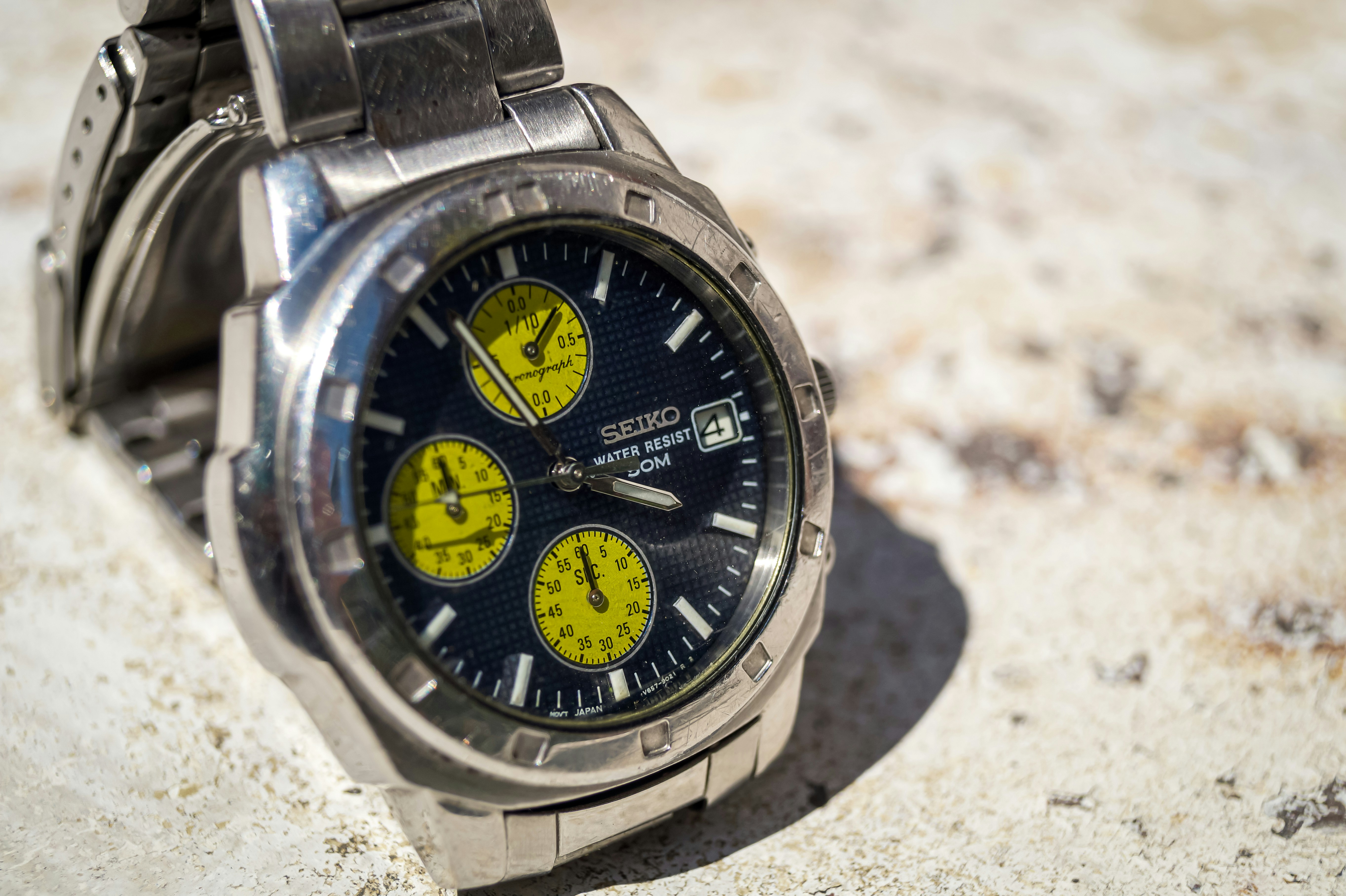 Sunlit Seiko: A Weathered Chronograph Resting in Sand